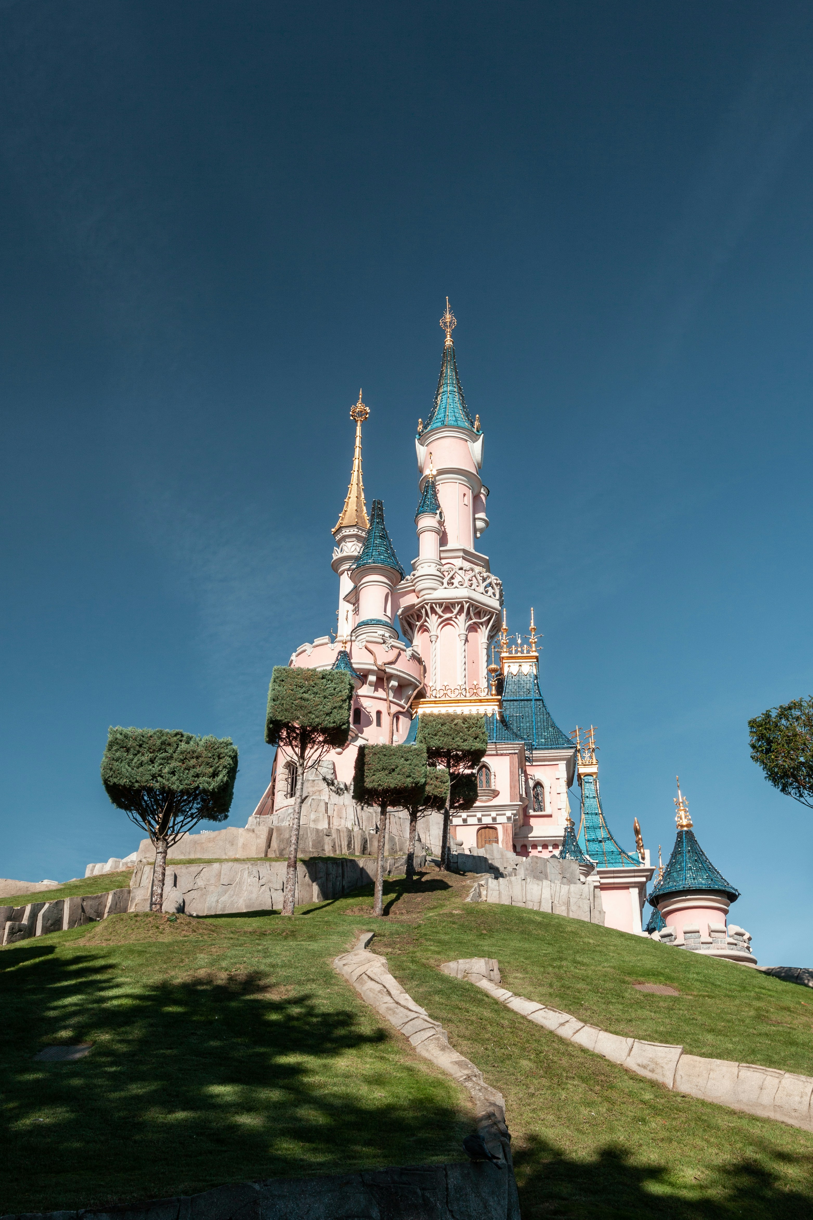 Castle on the Hill: Pink Turrets Above the Winding Path