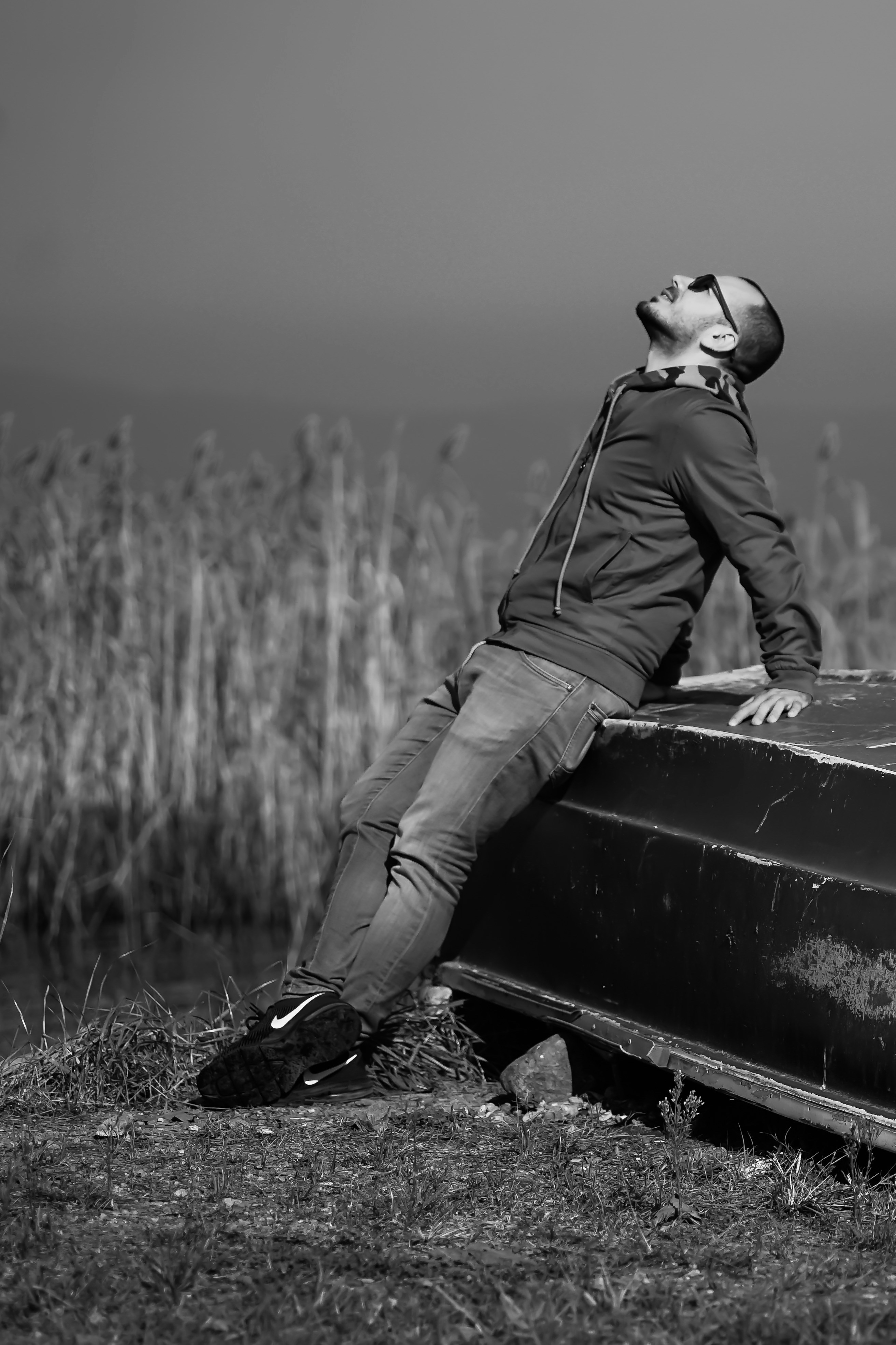 man leaning on boat on the ground