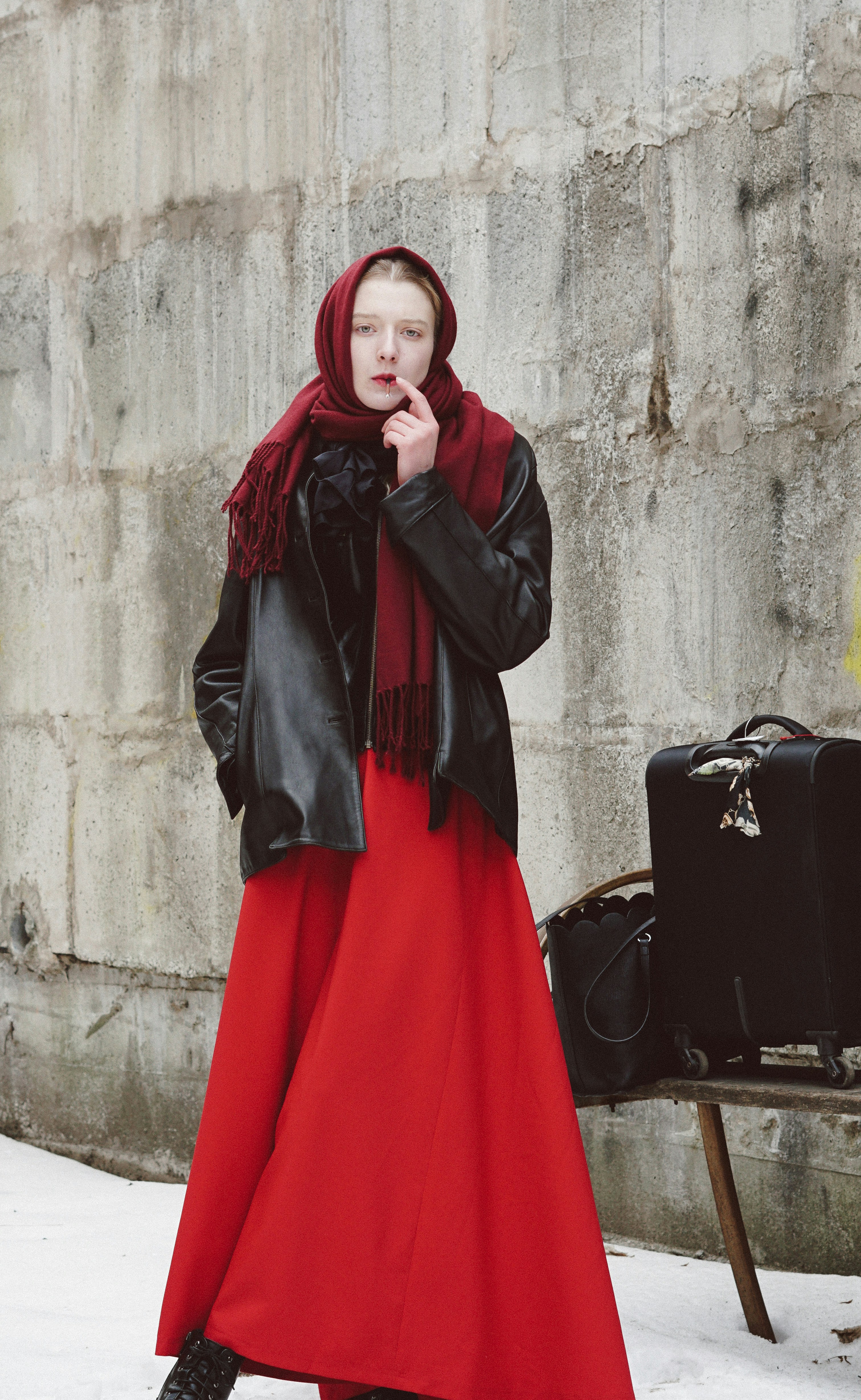 Crimson Gown by the Concrete Wall: A Quiet Traveler's Moment