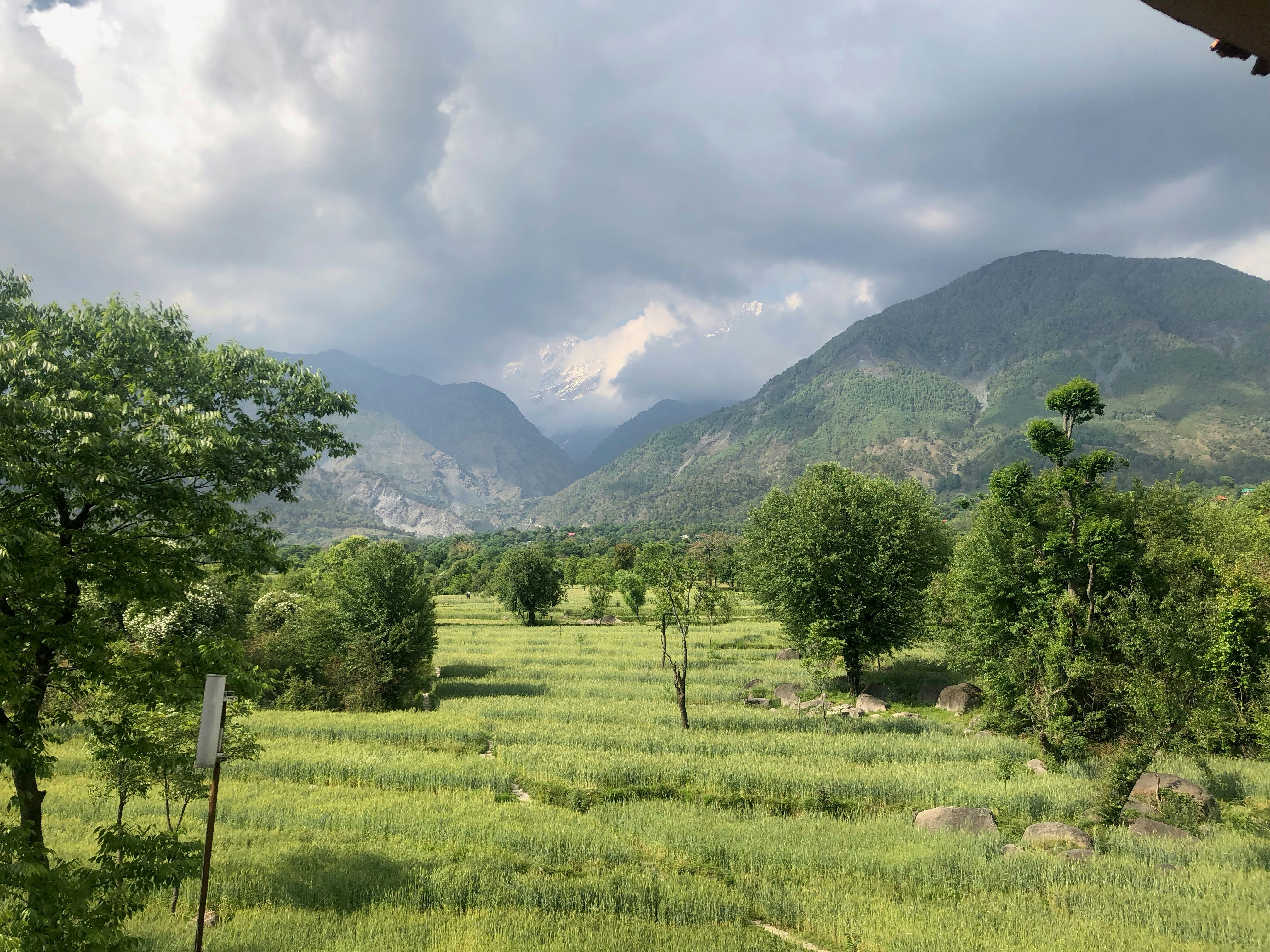 Terraced Green Valleys Framed by Cloud-Wrapped Peaks