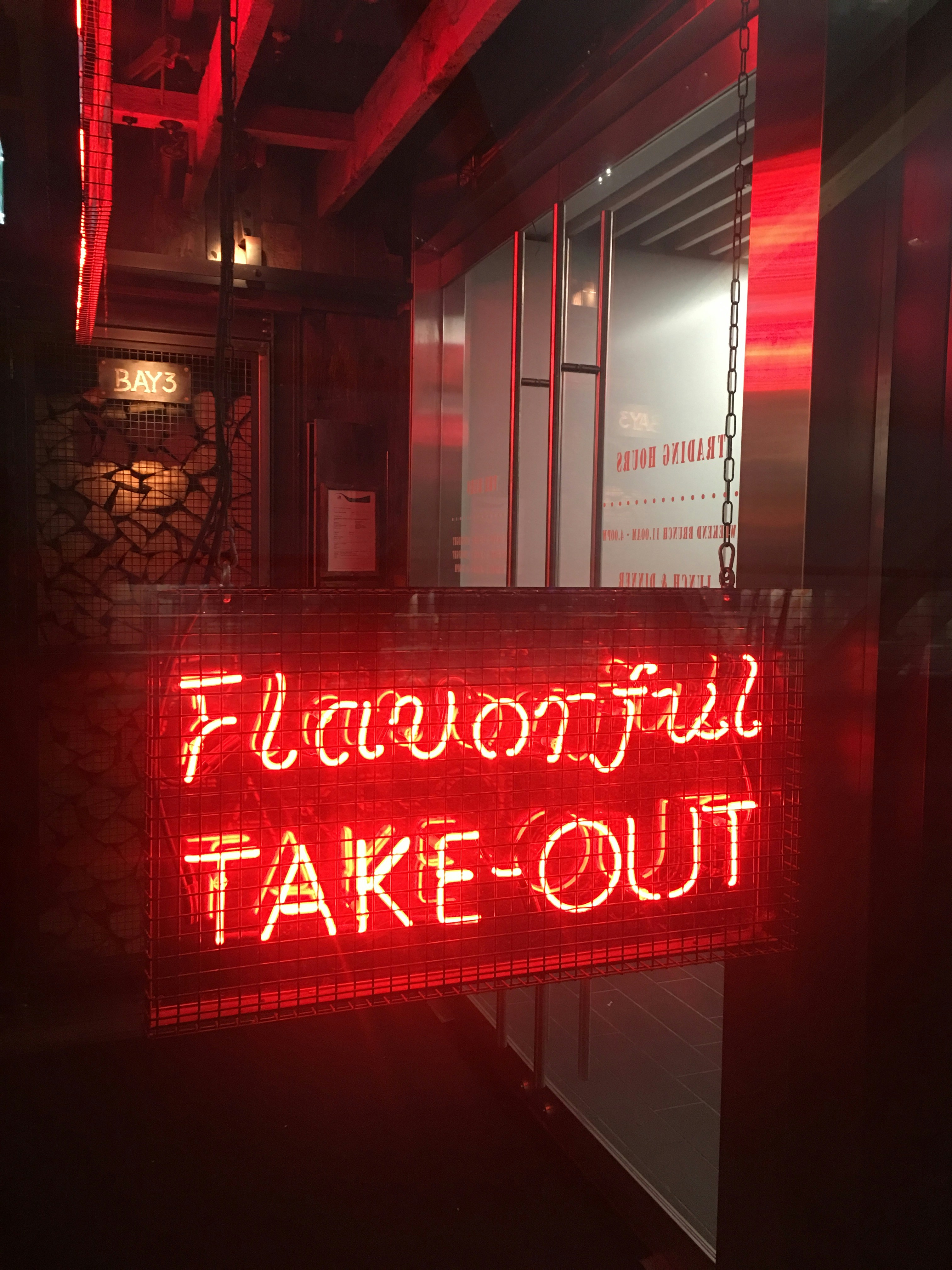 Neon Flavour: Night Take-Out Sign Reflected in Glass