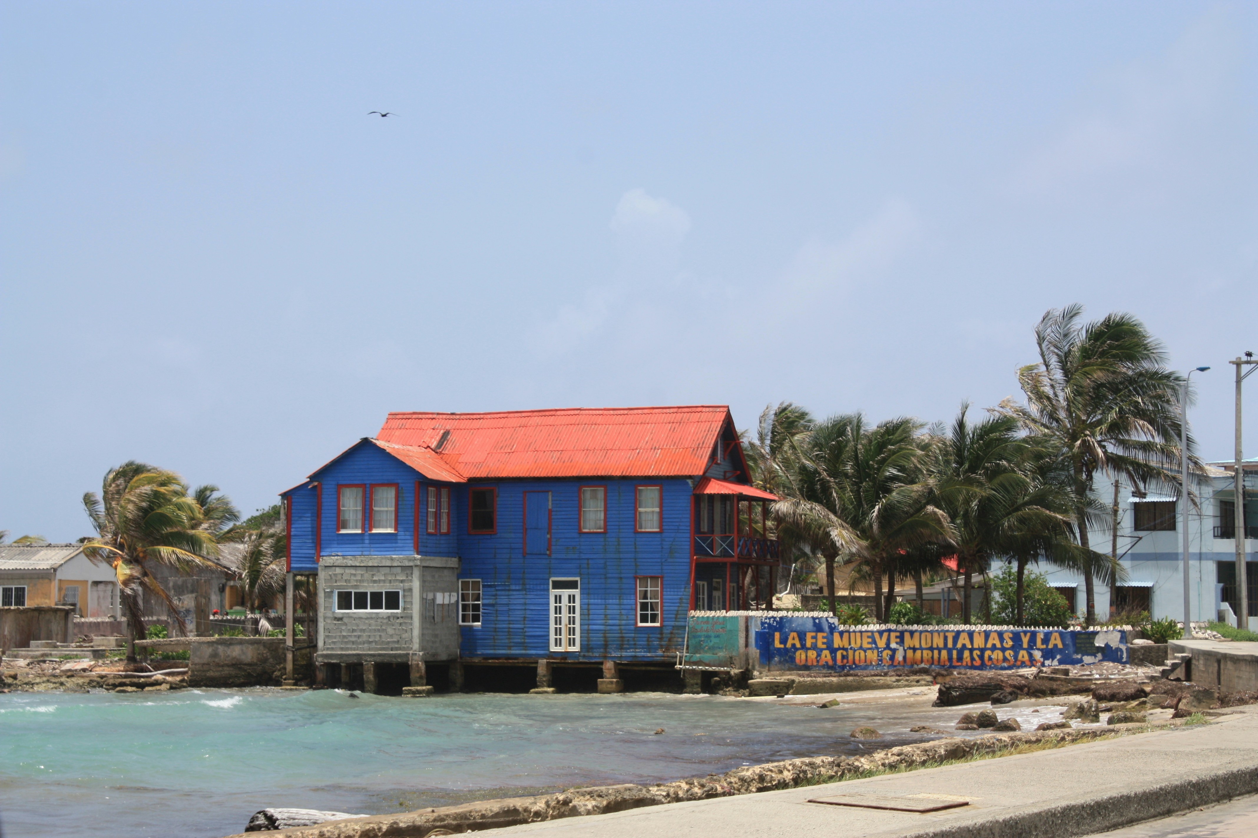 Blue and red house near body of water during daytime photo – Free ...