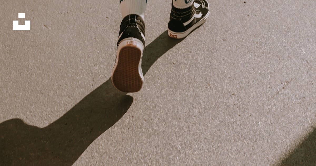 Person Wearing Black And White Nike Athletic Shoes Photo Free Brown