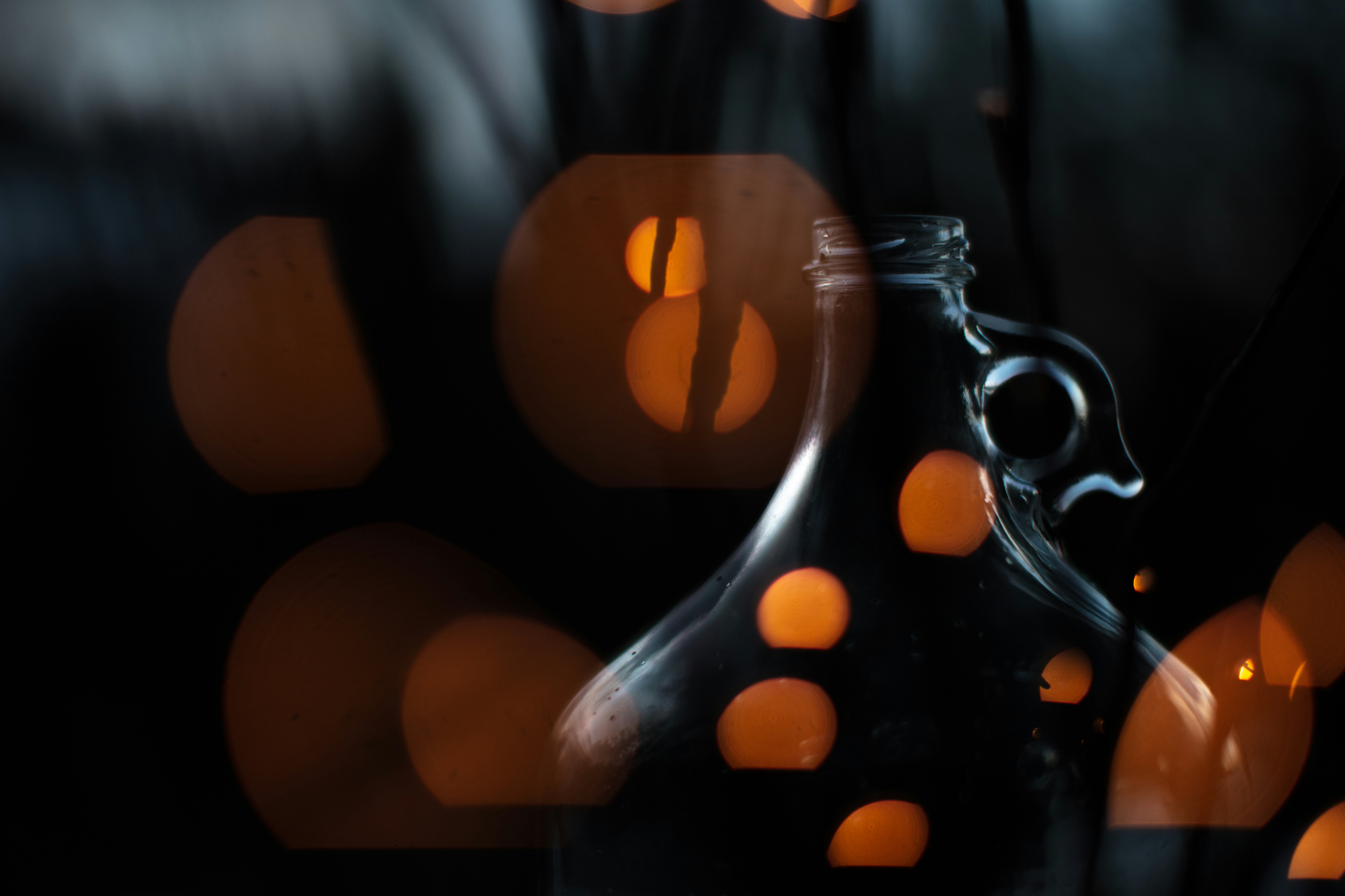 Glowing Orbs on a Dark Bottle: A Quiet Still Life