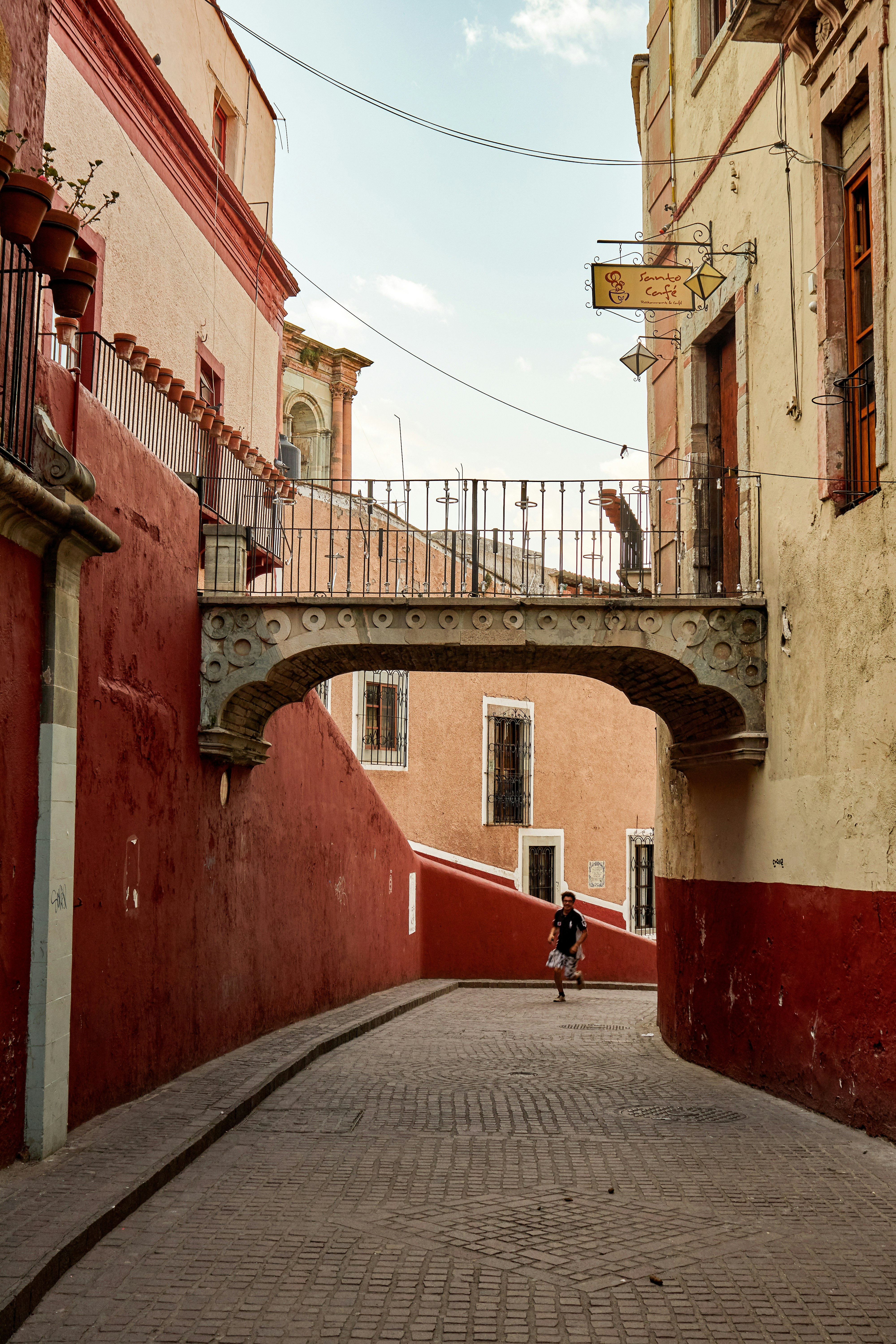 Under the Iron Arch: Sunlit Corridor of Red and Gold