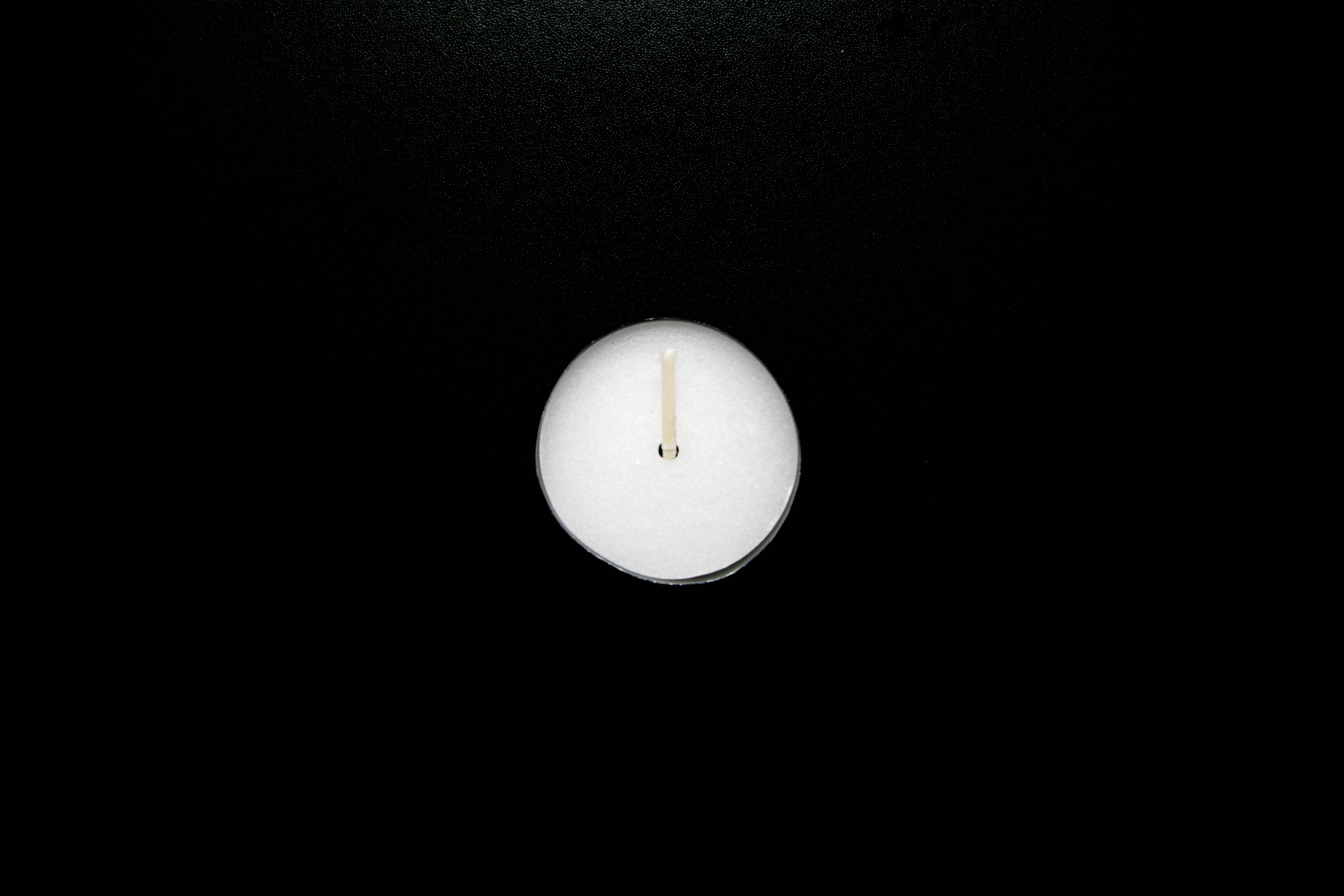 Centered Tealight in Velvet Night: A Minimalist Glow