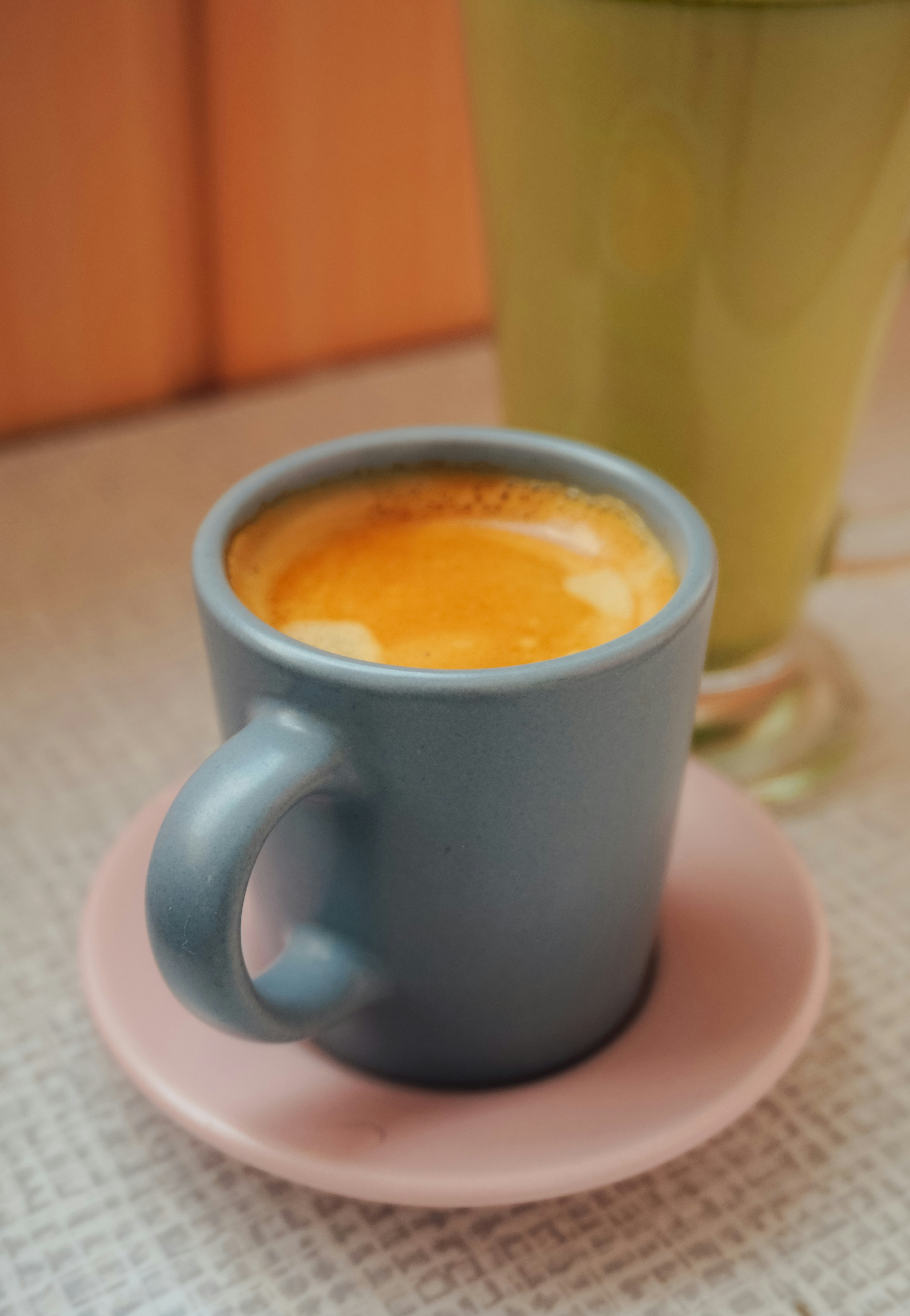 blue ceramic mug with brown liquid inside