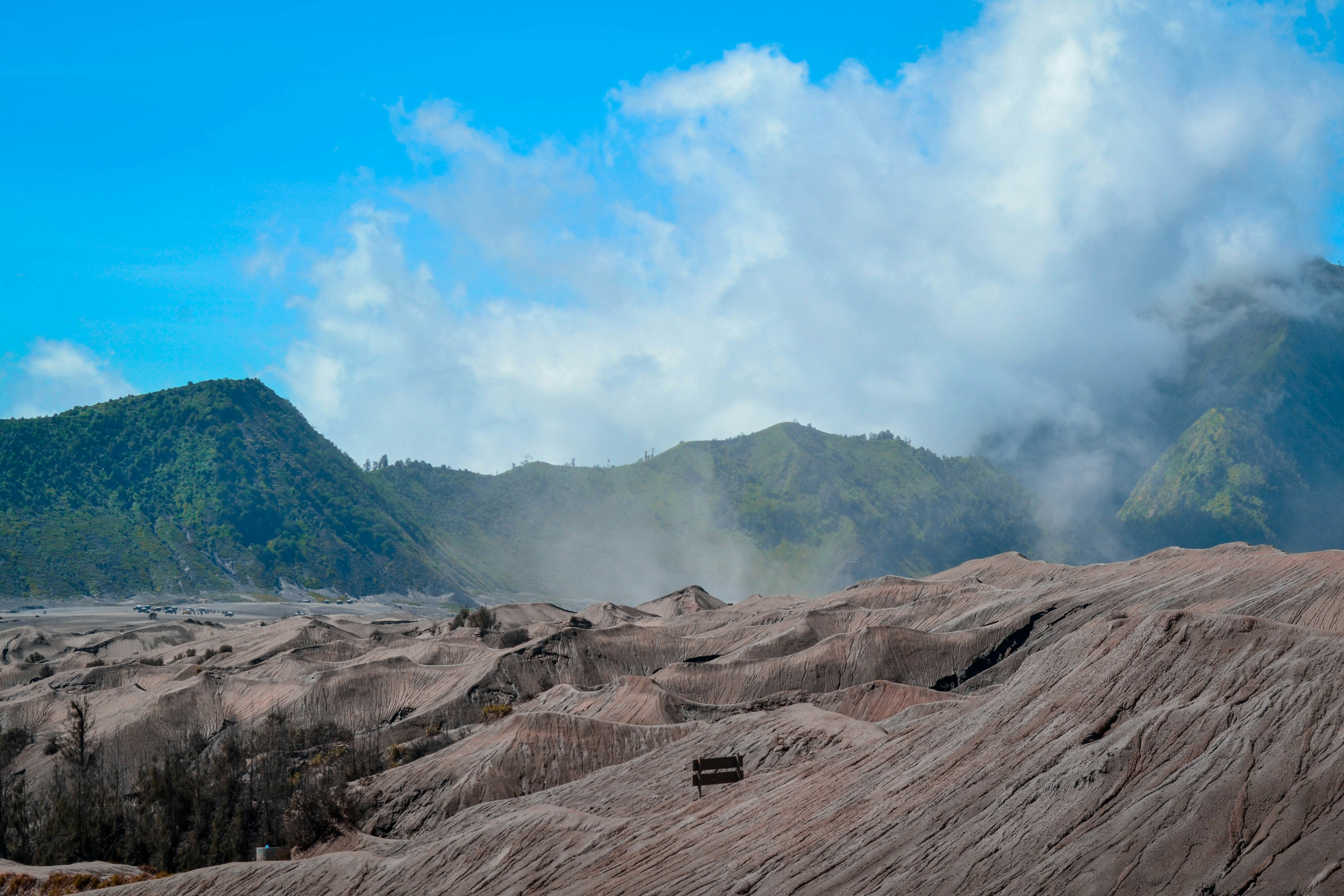Lone Bench on Sculpted Lava Field Beneath a Crown of Clouds
