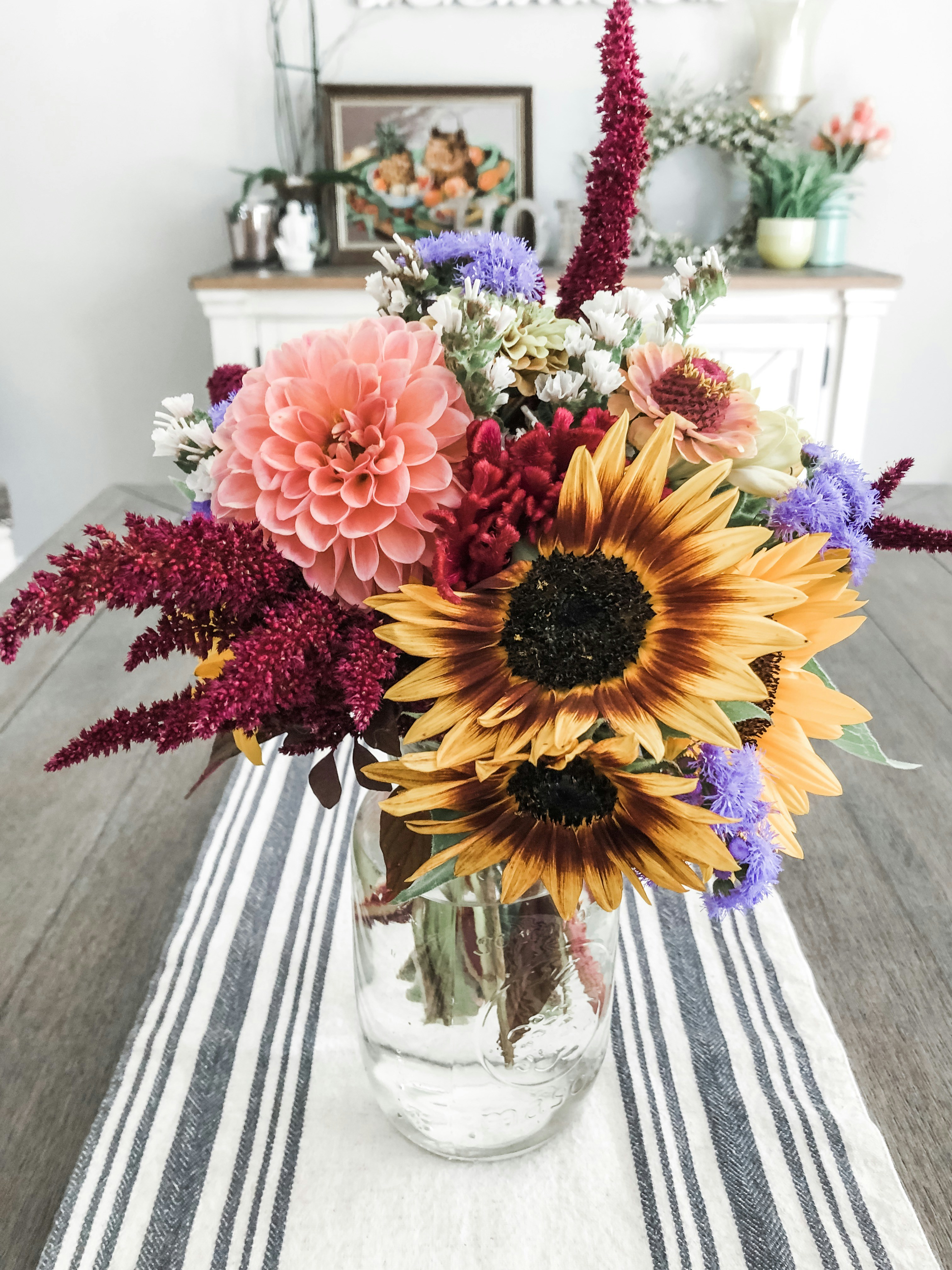 Sunburst Bouquet in Glass Vase on Striped Runner