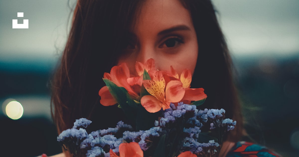 Woman In Red And White Floral Shirt Holding Orange Flower Photo Free