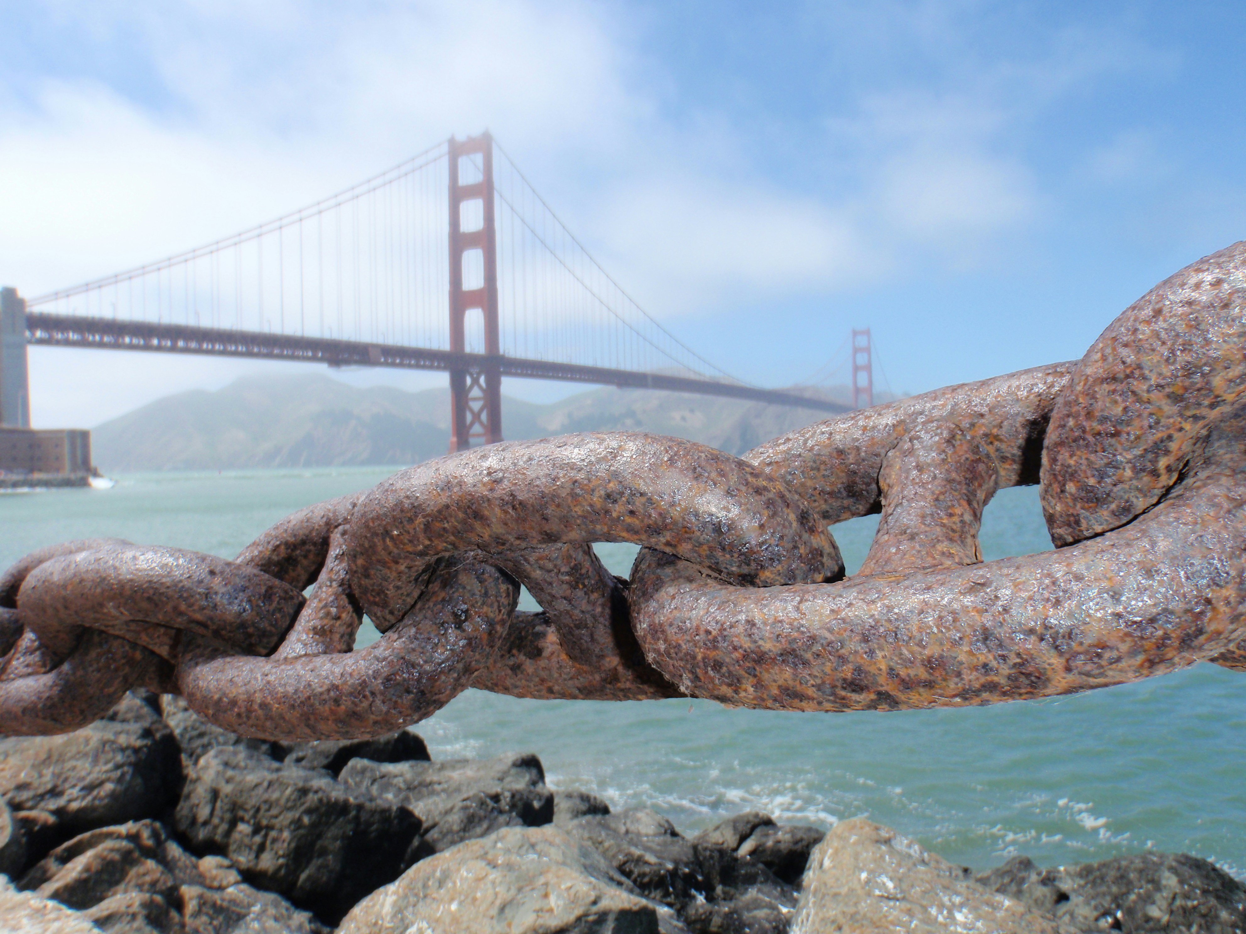 Rusty Chain Framing the Golden Gate: A Close-Range Study of Scale