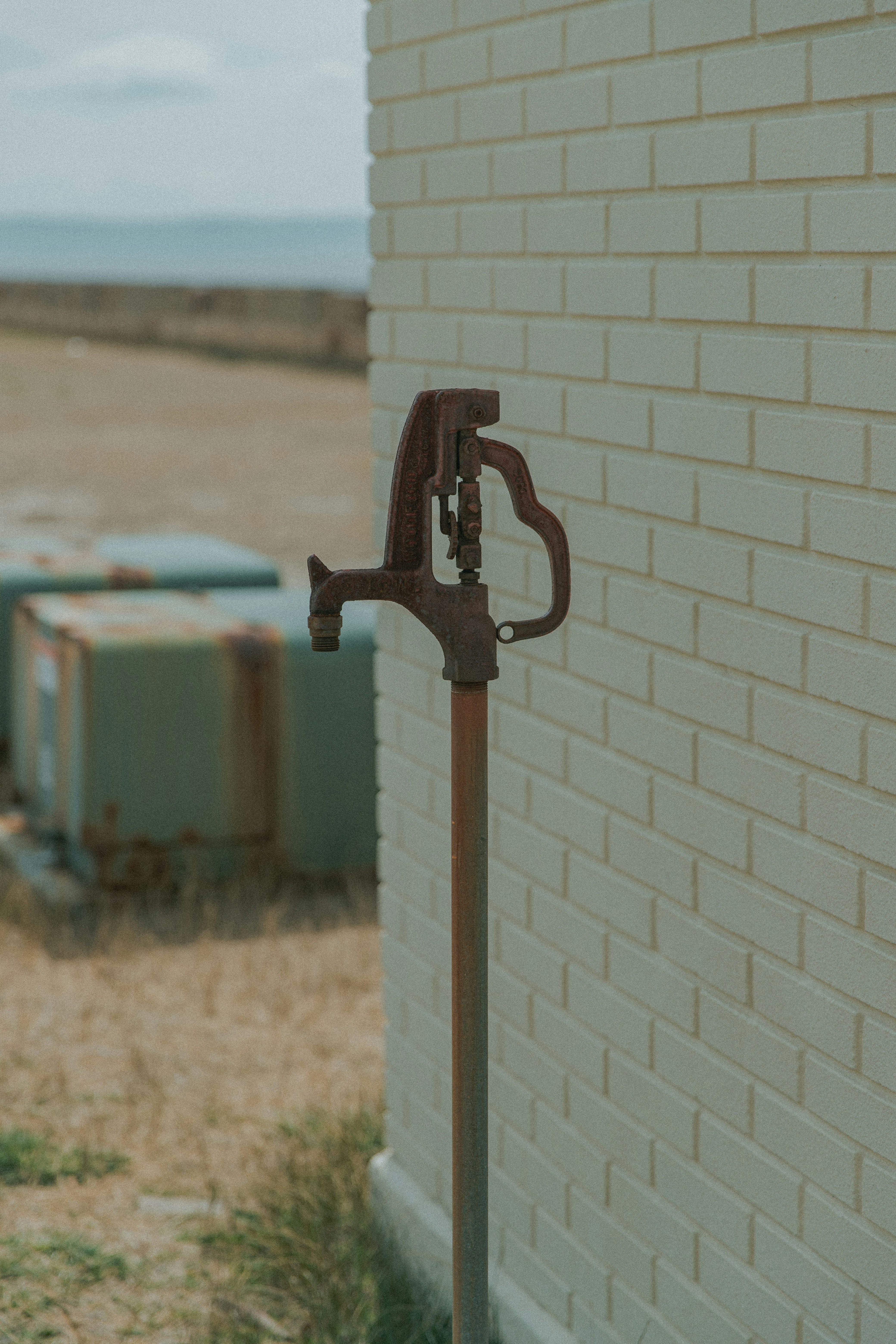 Rusty Spigot Against a Quiet Brick Wall