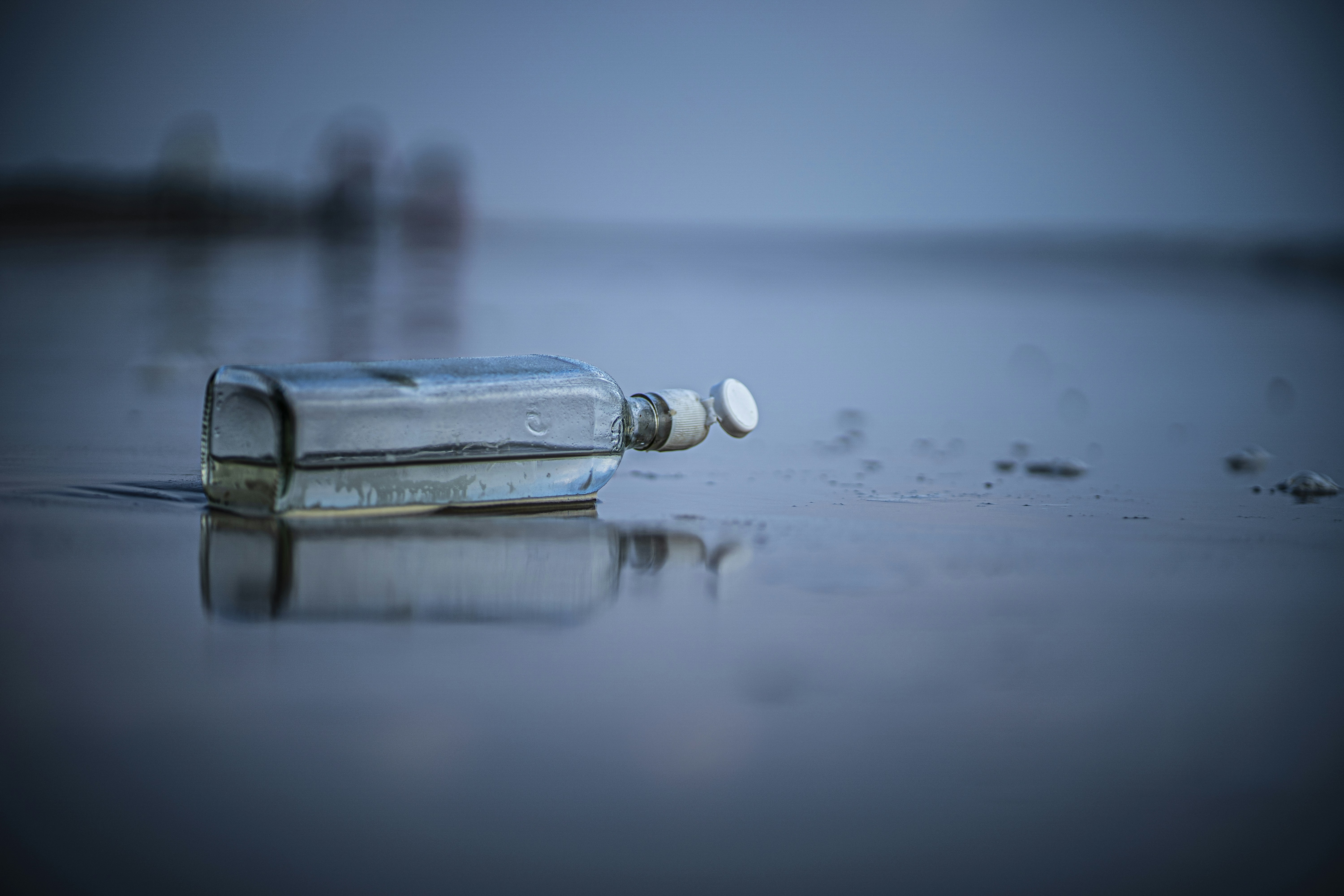 blue glass bottle on white table