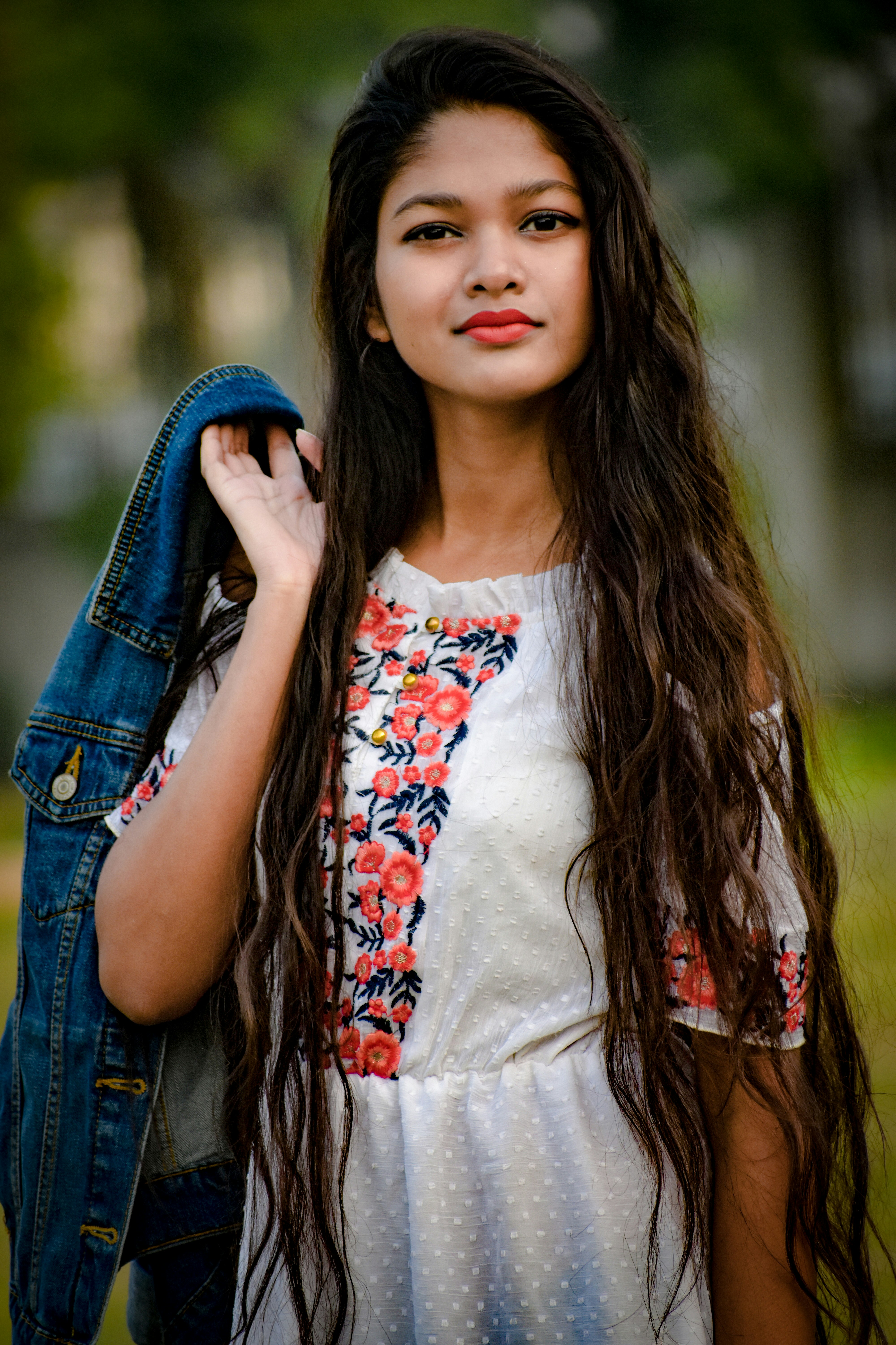 Heritage Threads: Portrait of a Young Woman in Floral Embellishments