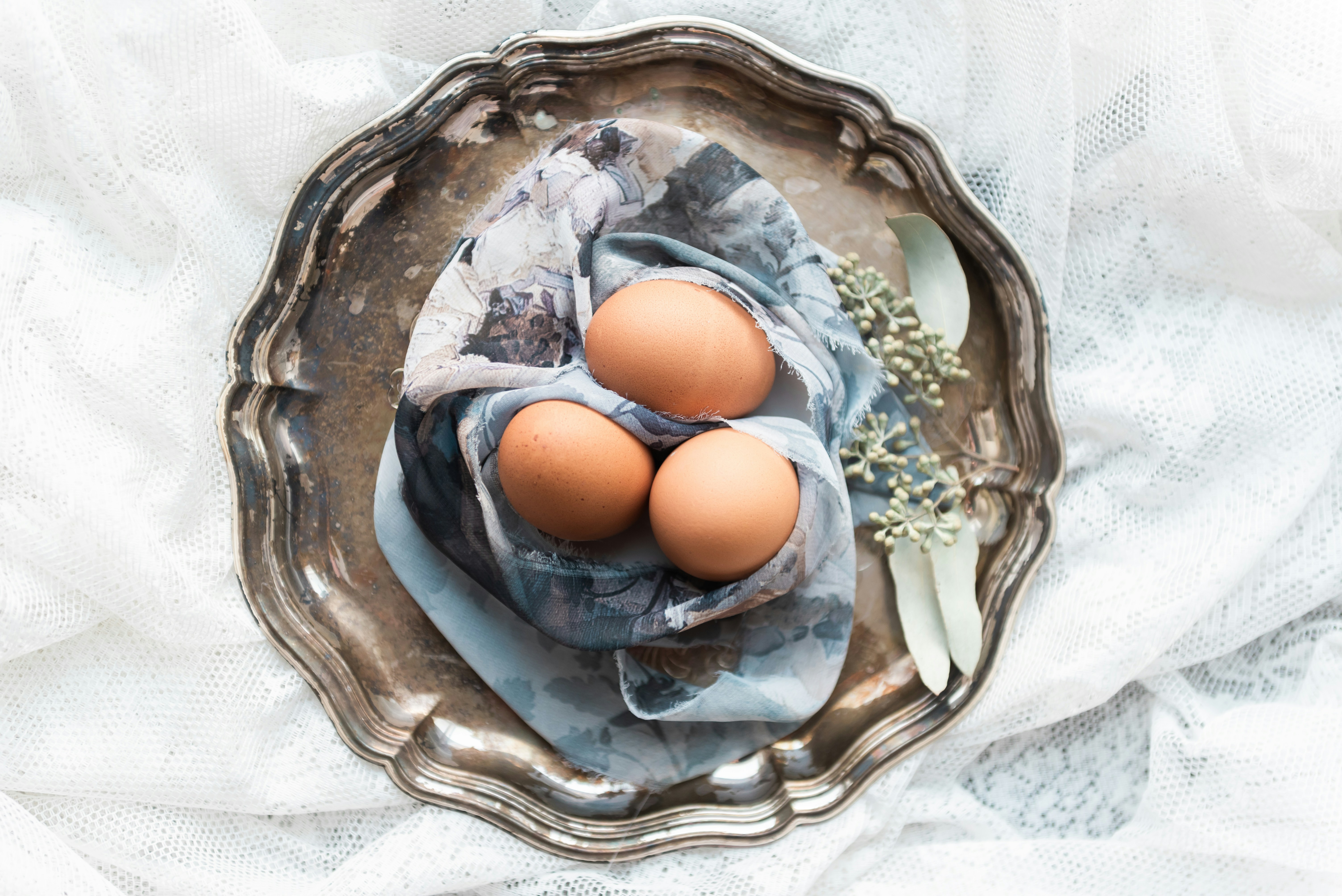 Trio of Rustic Eggs Cradled in an Aged Silver Tray