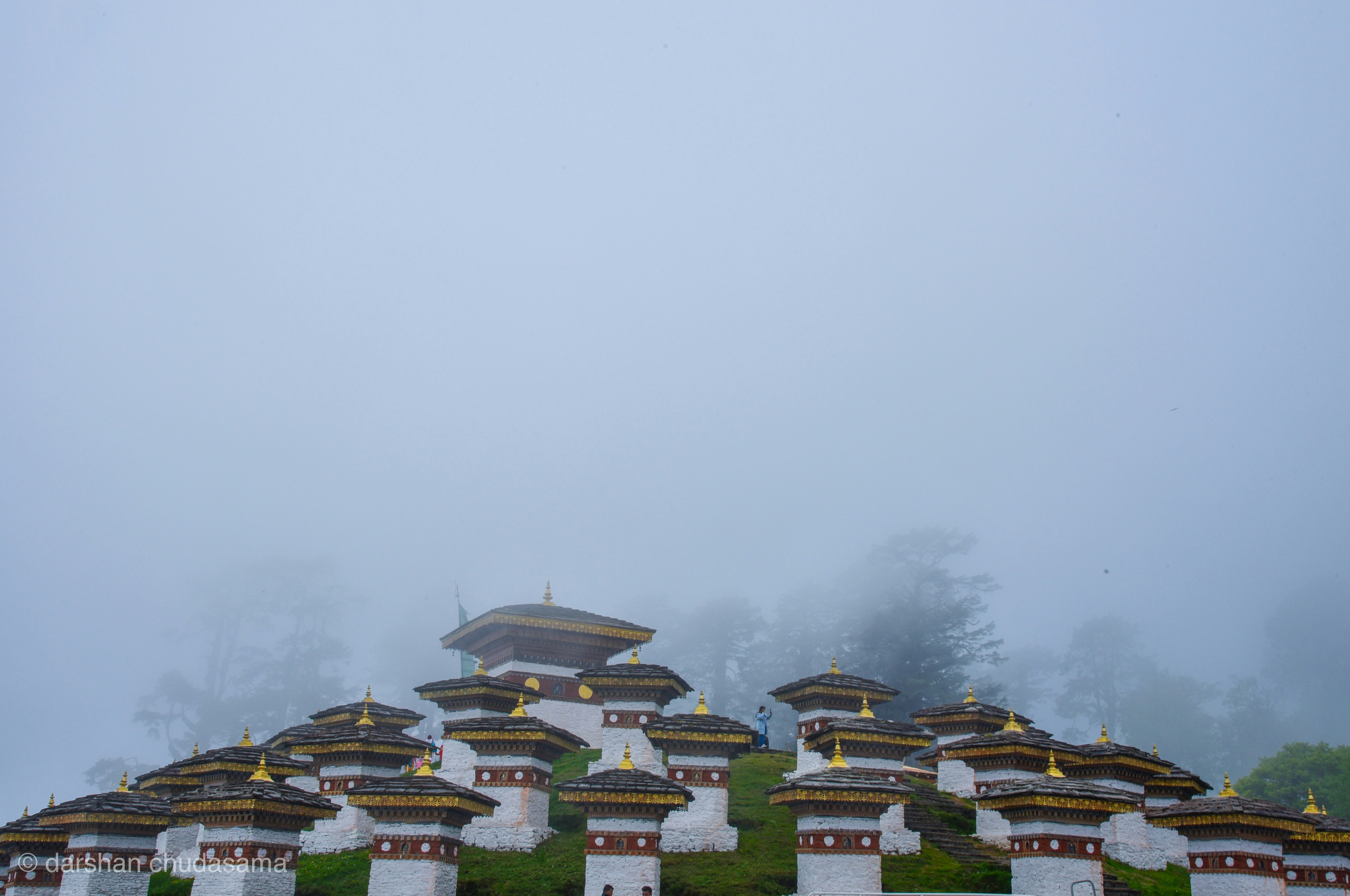 Mist-Wrapped Stupa Ridge: A Row of Gold-Topped Chortens