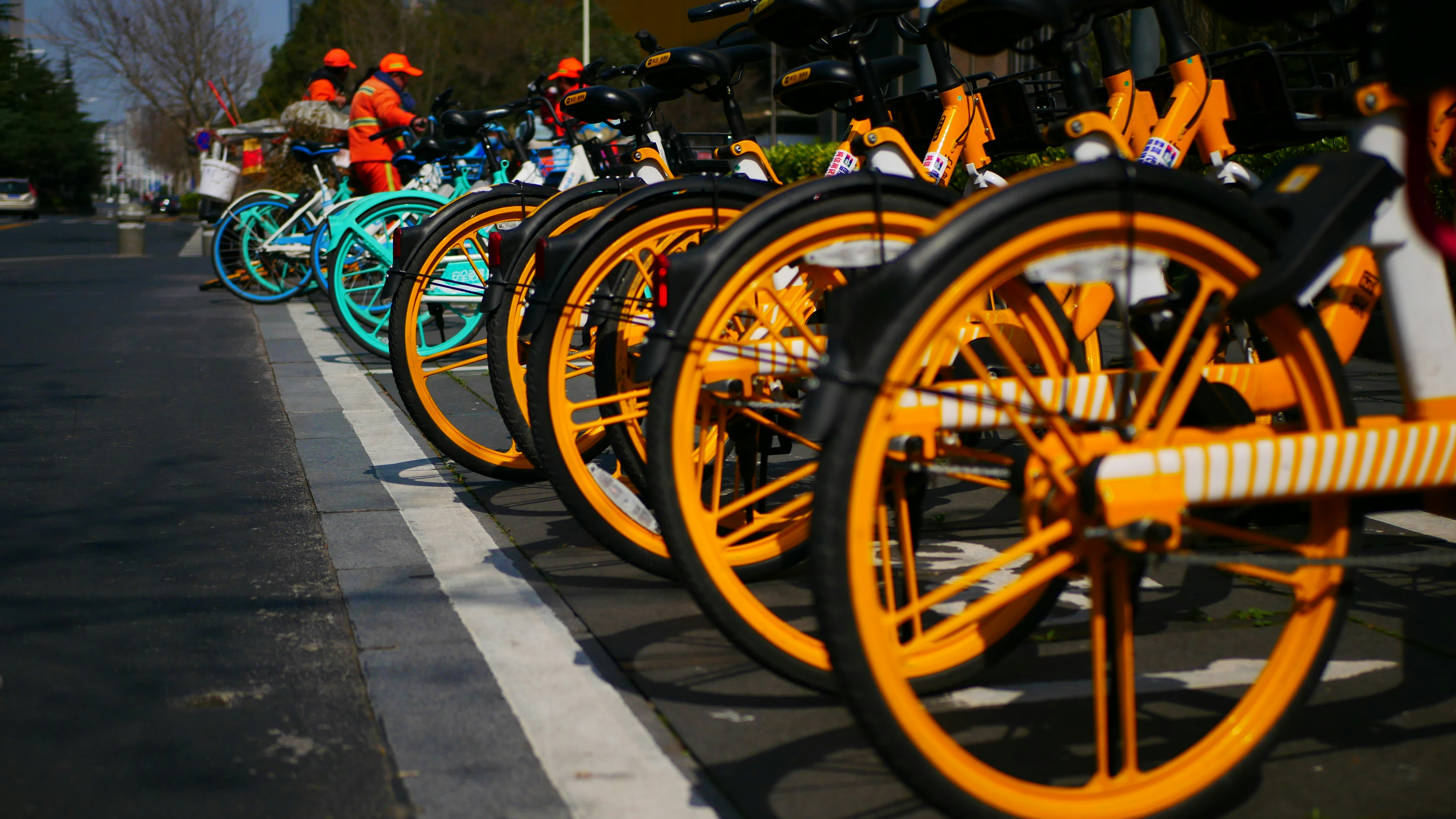 Yellow and black bicycle wheel on gray concrete road during daytime ...