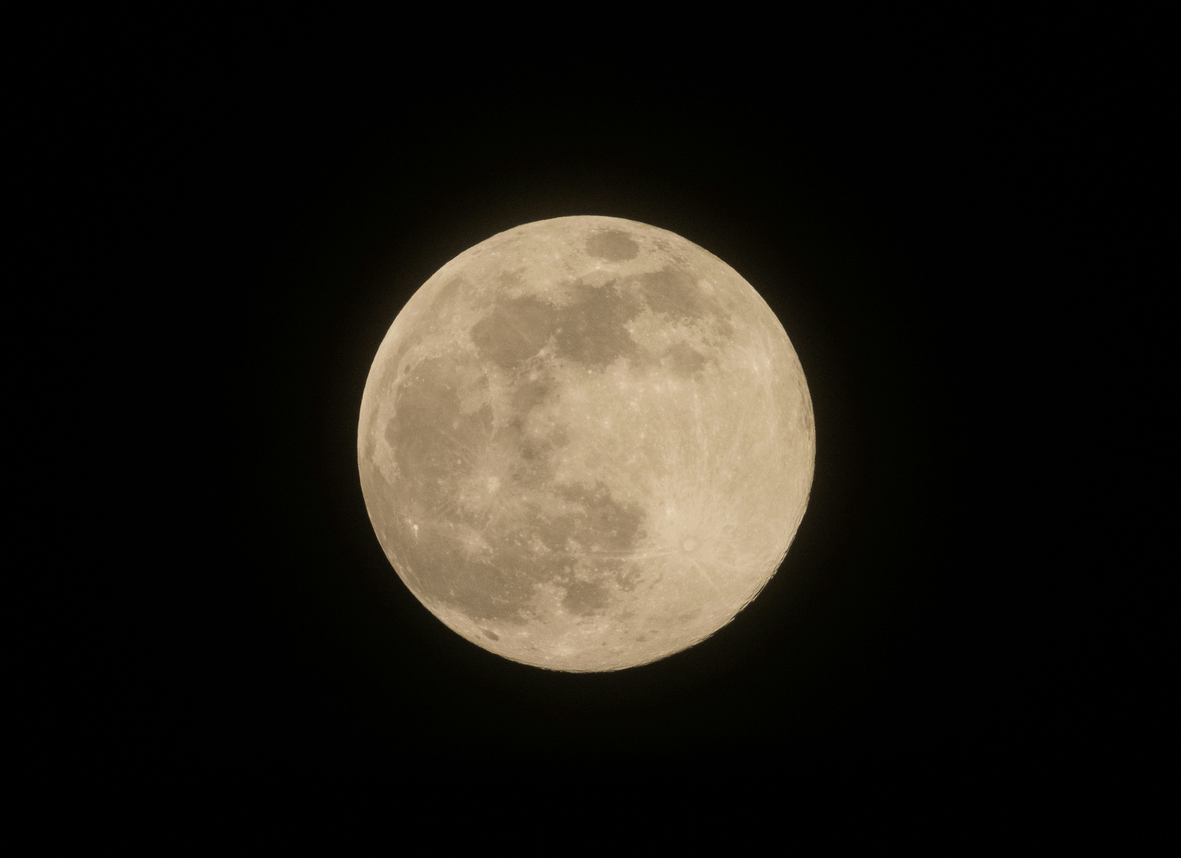 Full moon against a dark night sky, showcasing surface textures and craters.