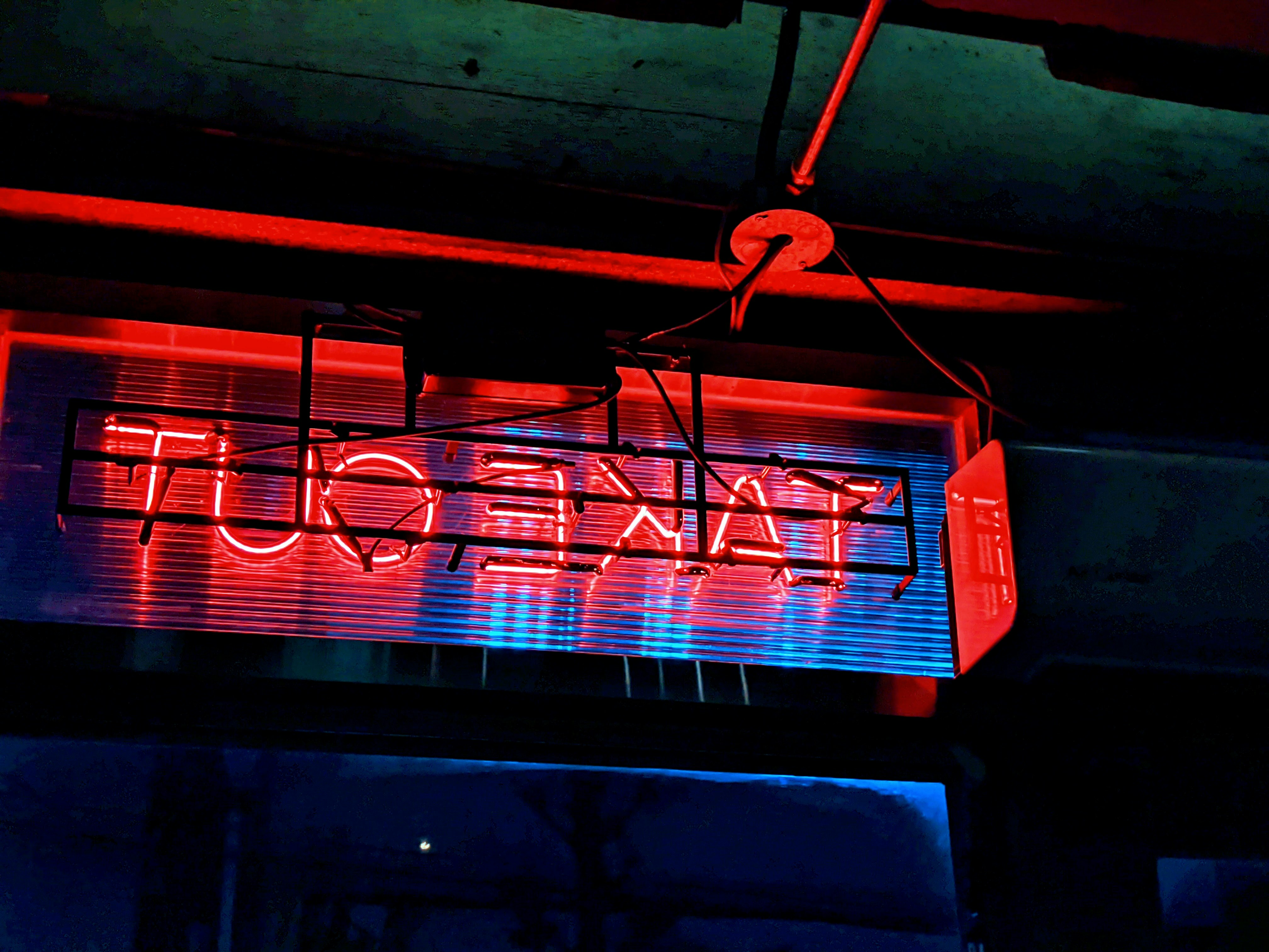 Neon Clockwork: Red and Blue Signage in Midnight Jazz Bar