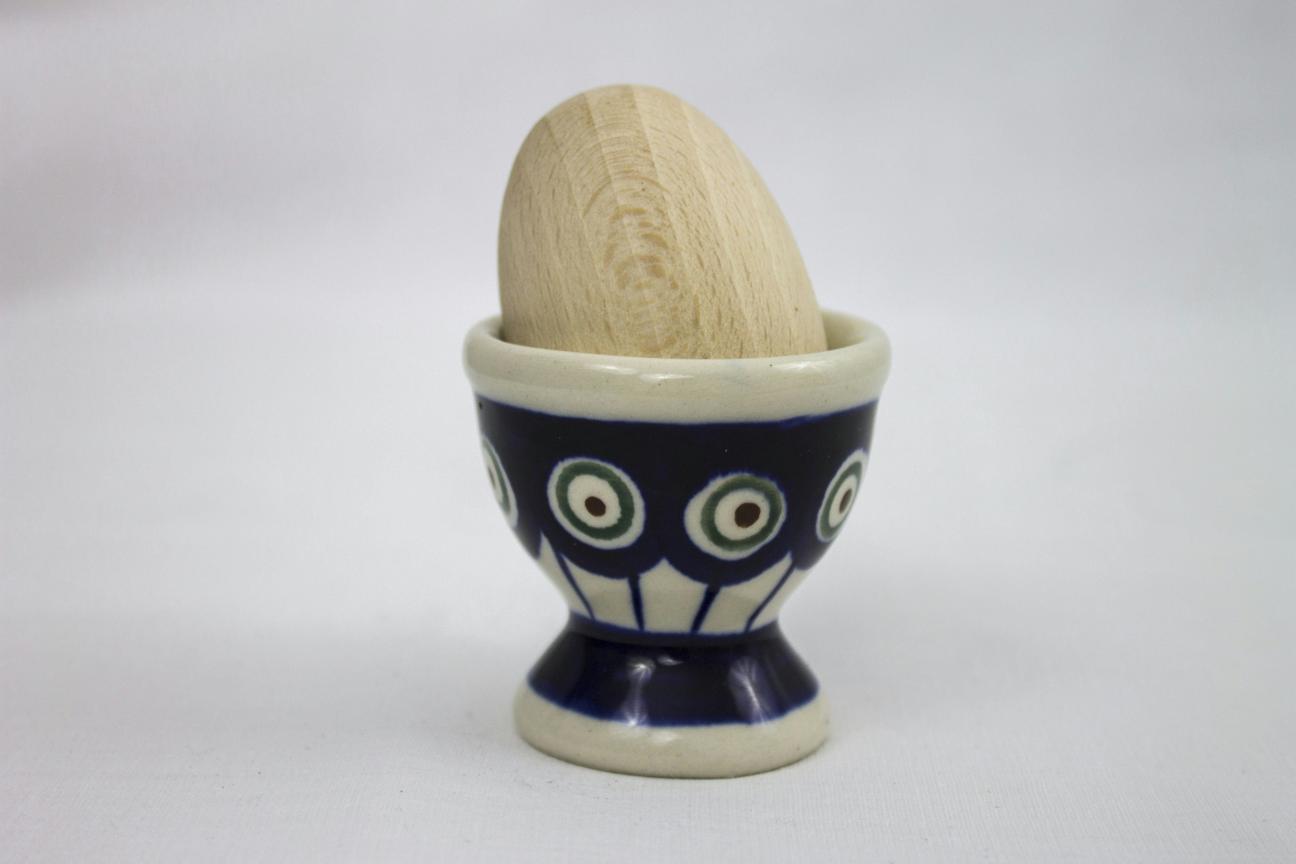 Ceramic Egg Cup Portrait: Wood Grain Against Glazed Blue