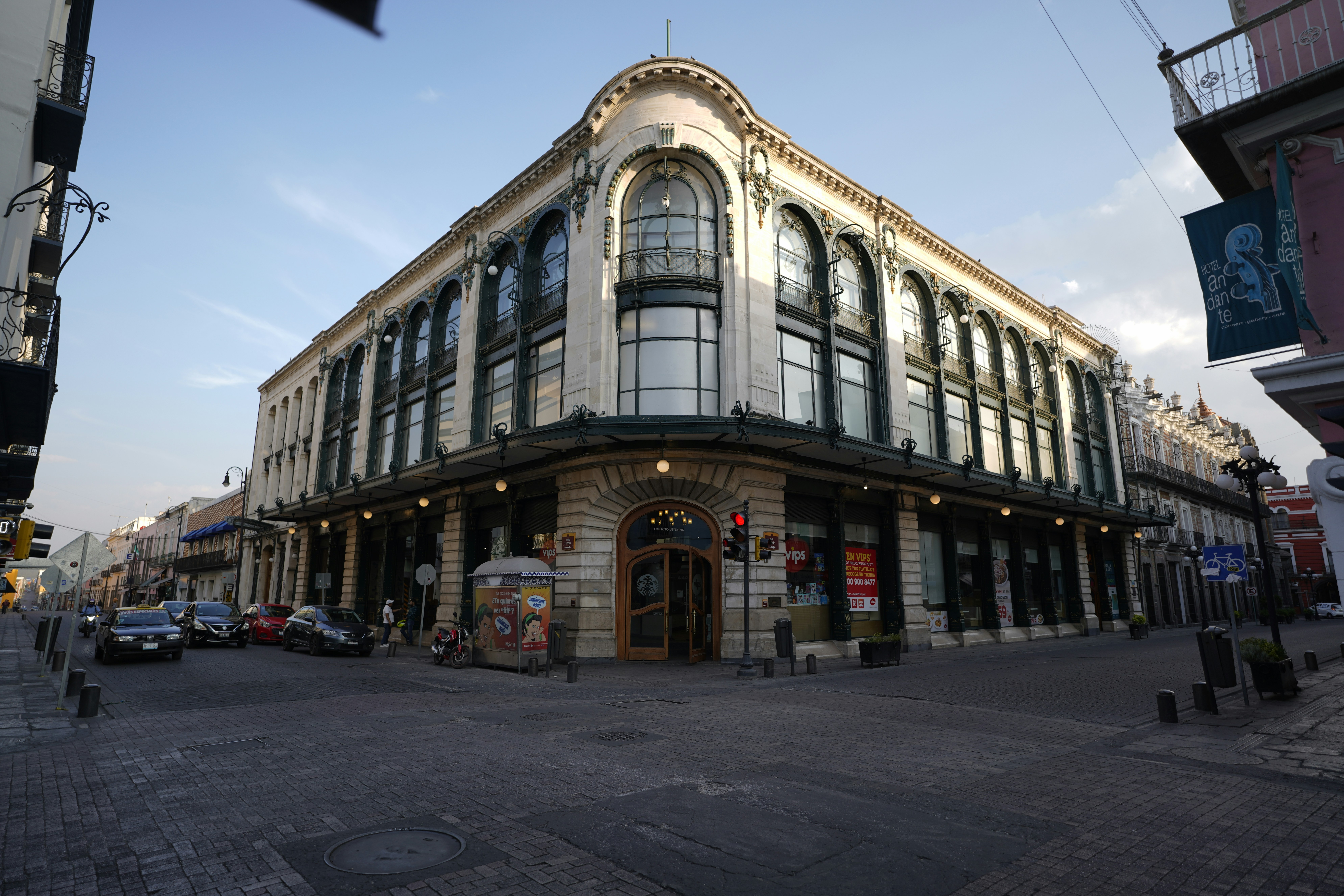 Historic corner building with art deco windows under a clear evening sky.