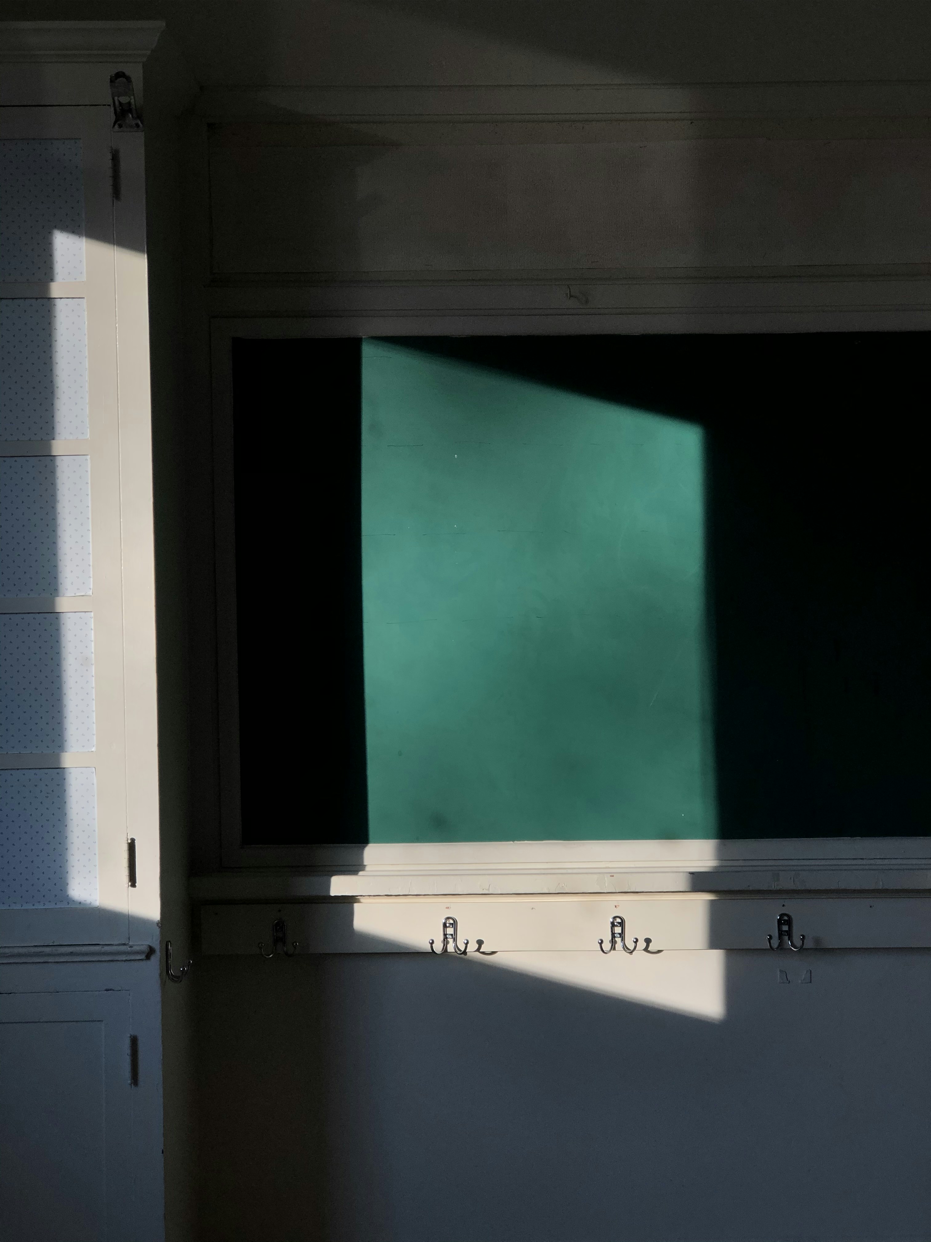 Teal Panel in a Shadowed Window Frame