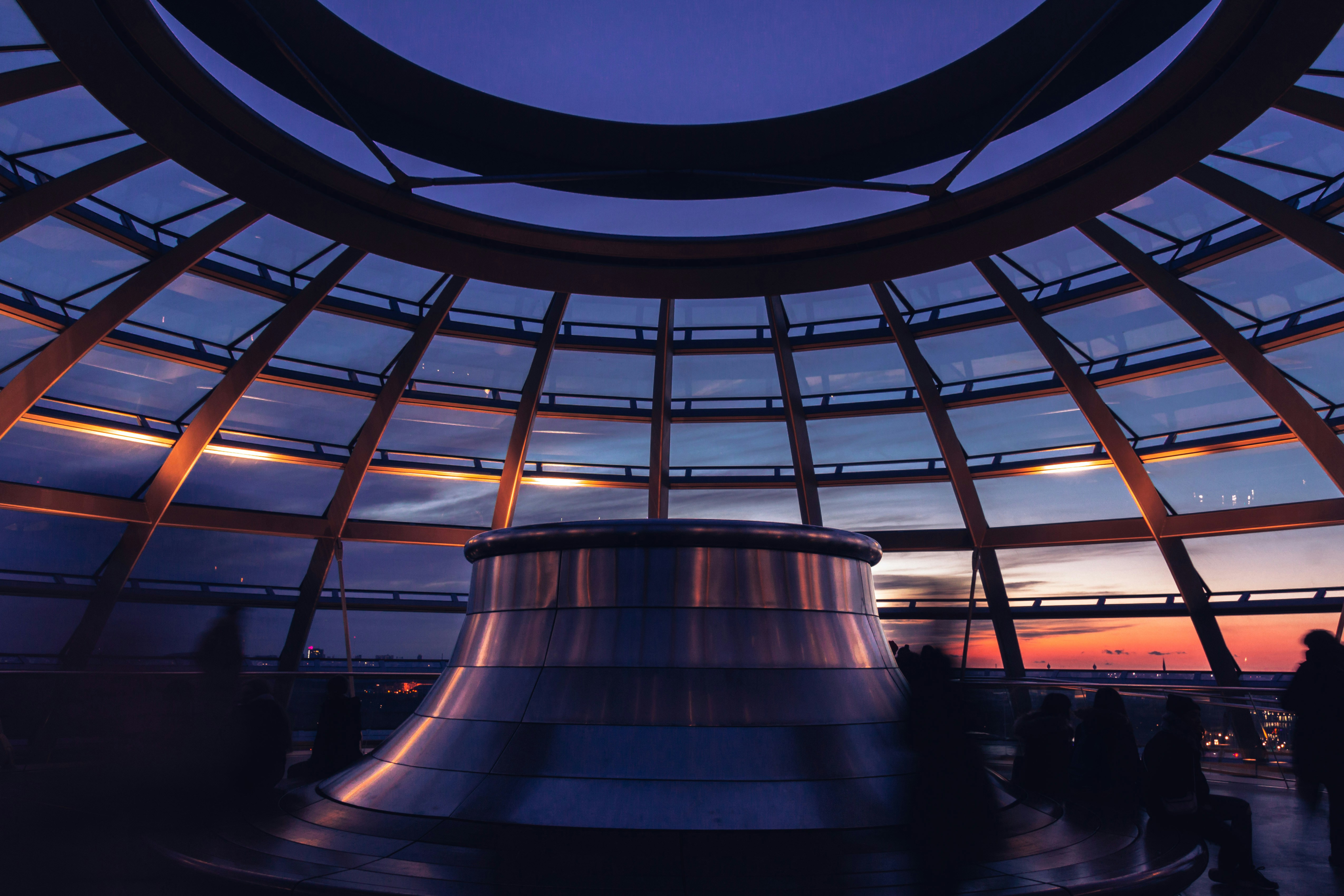 Dusk in the Glass Rotunda: Sunset Rings and a Moving Crowd