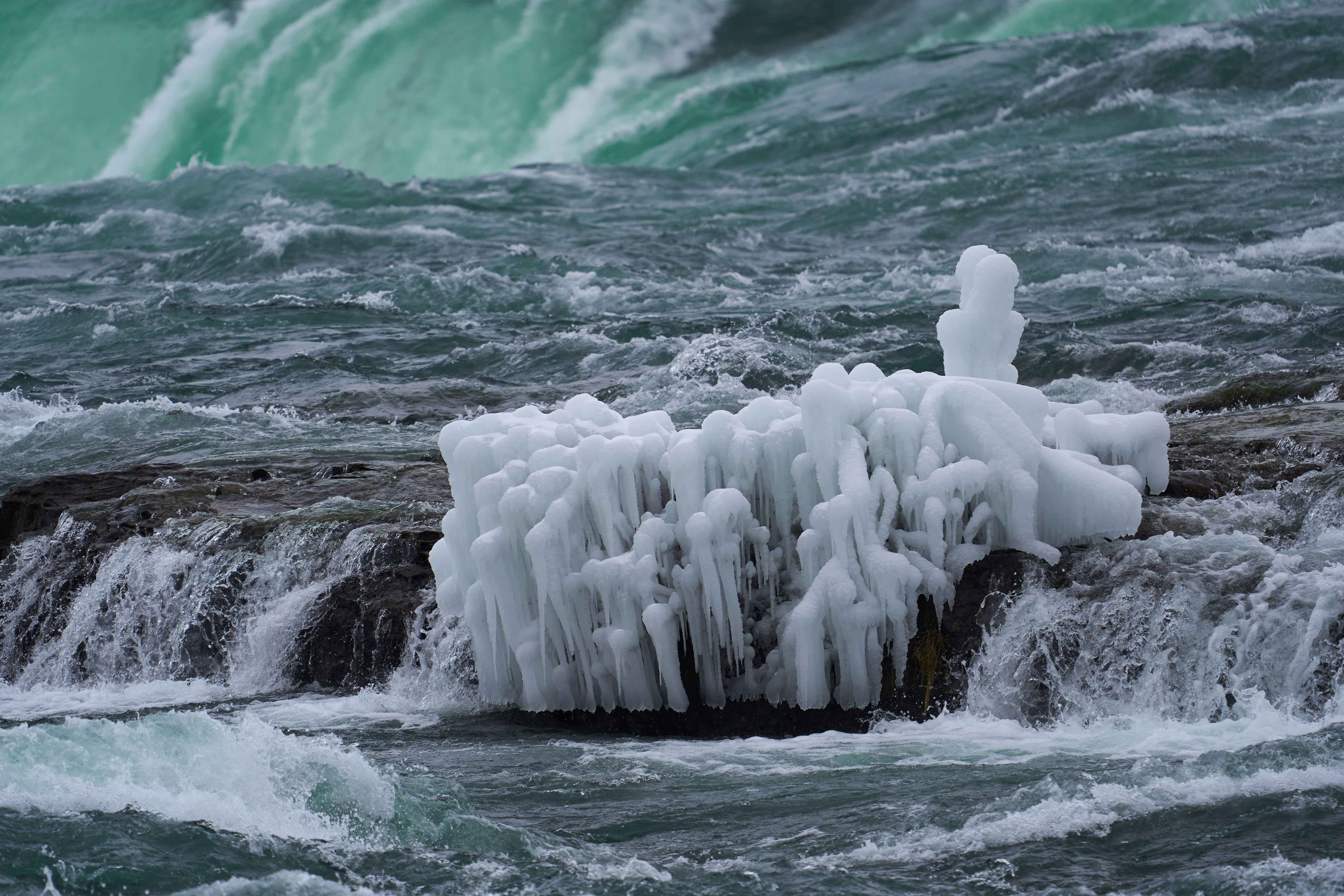 Icebound Outcrop Adrift Above Roaring Turquoise Swells