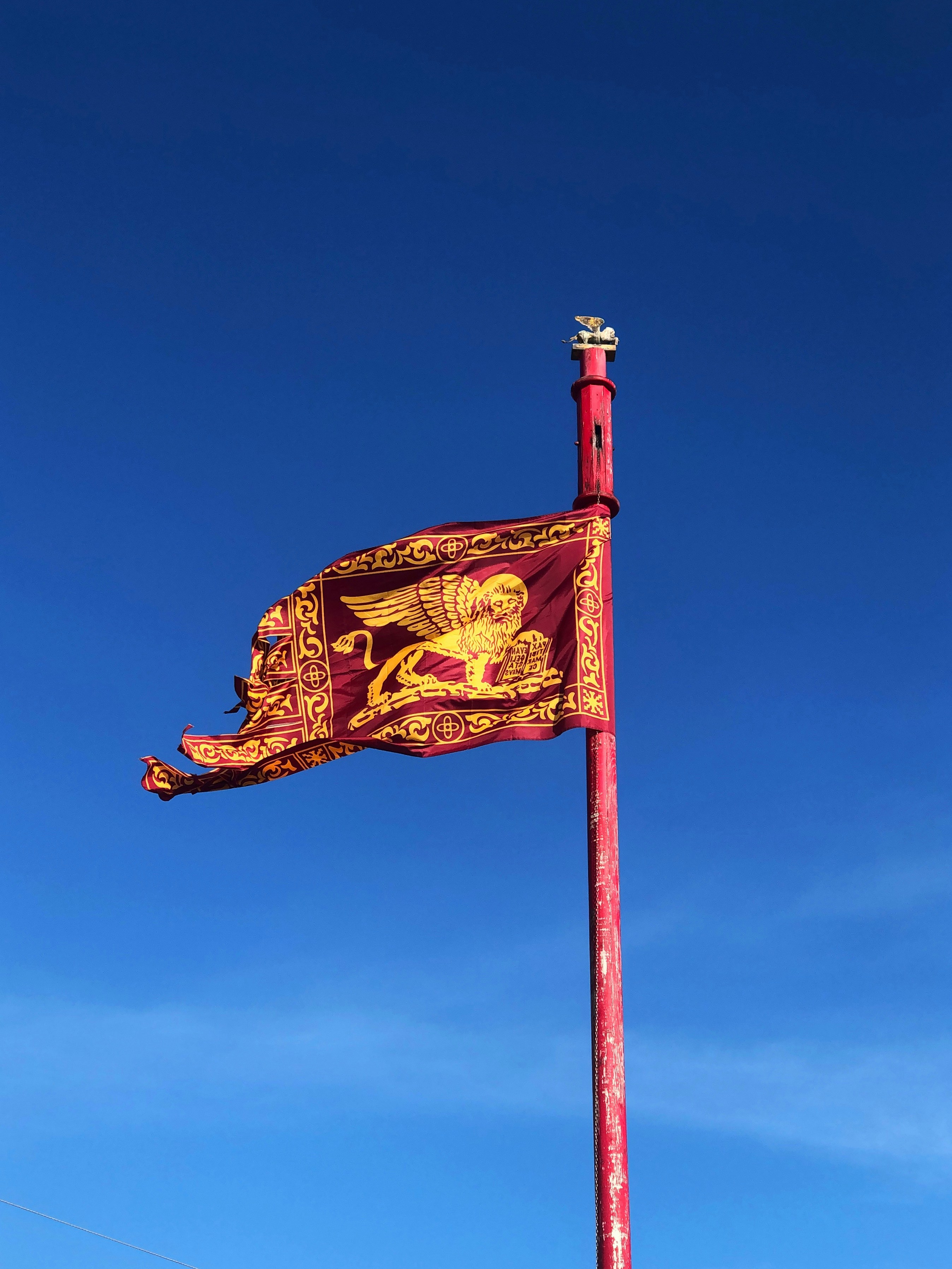 Red and gold flag under blue sky during daytime photo – Free Venice ...