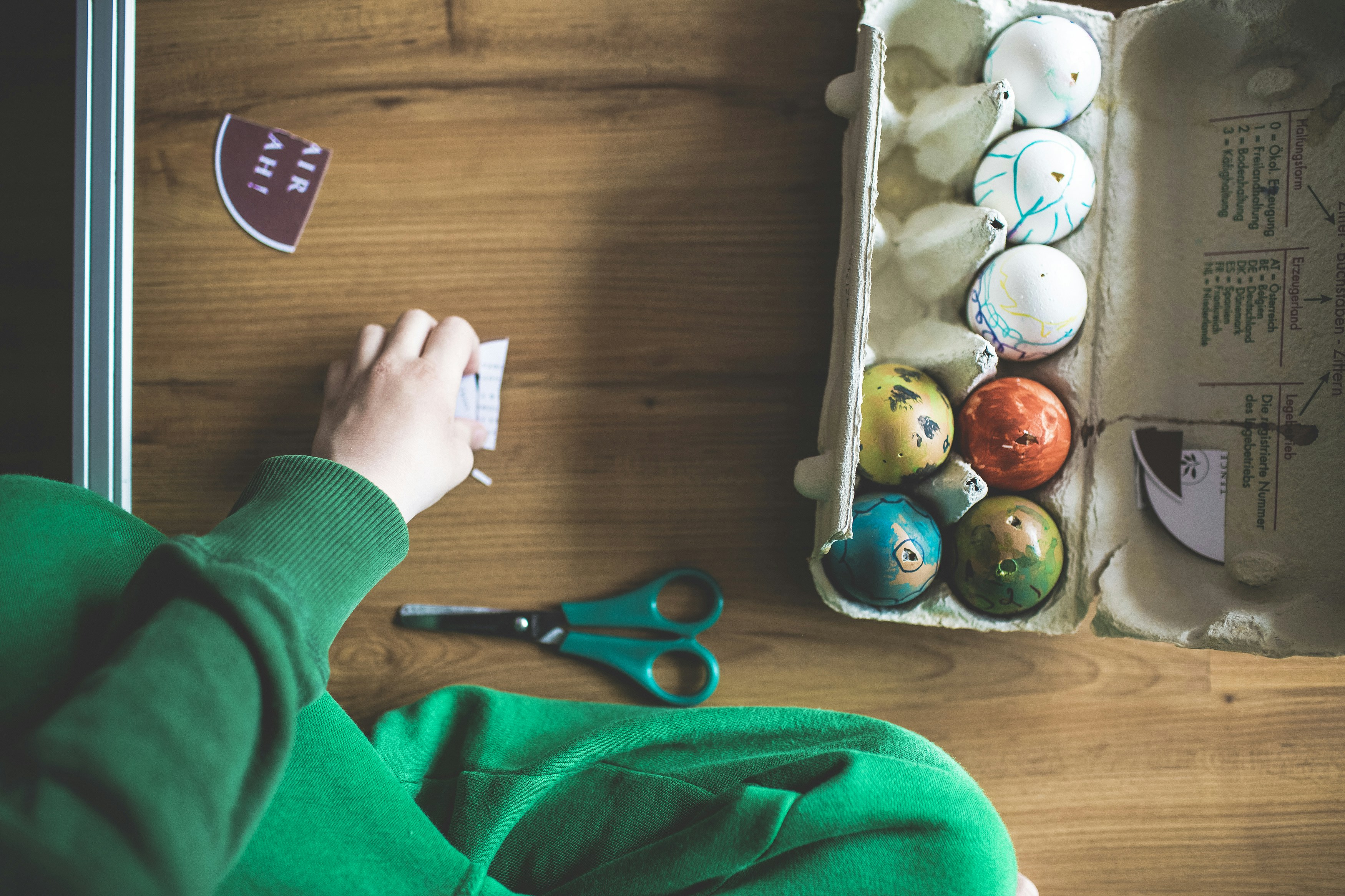 Green-Sleeved Organizer: Crafting Snips and Painted Eggs in a Morning Light