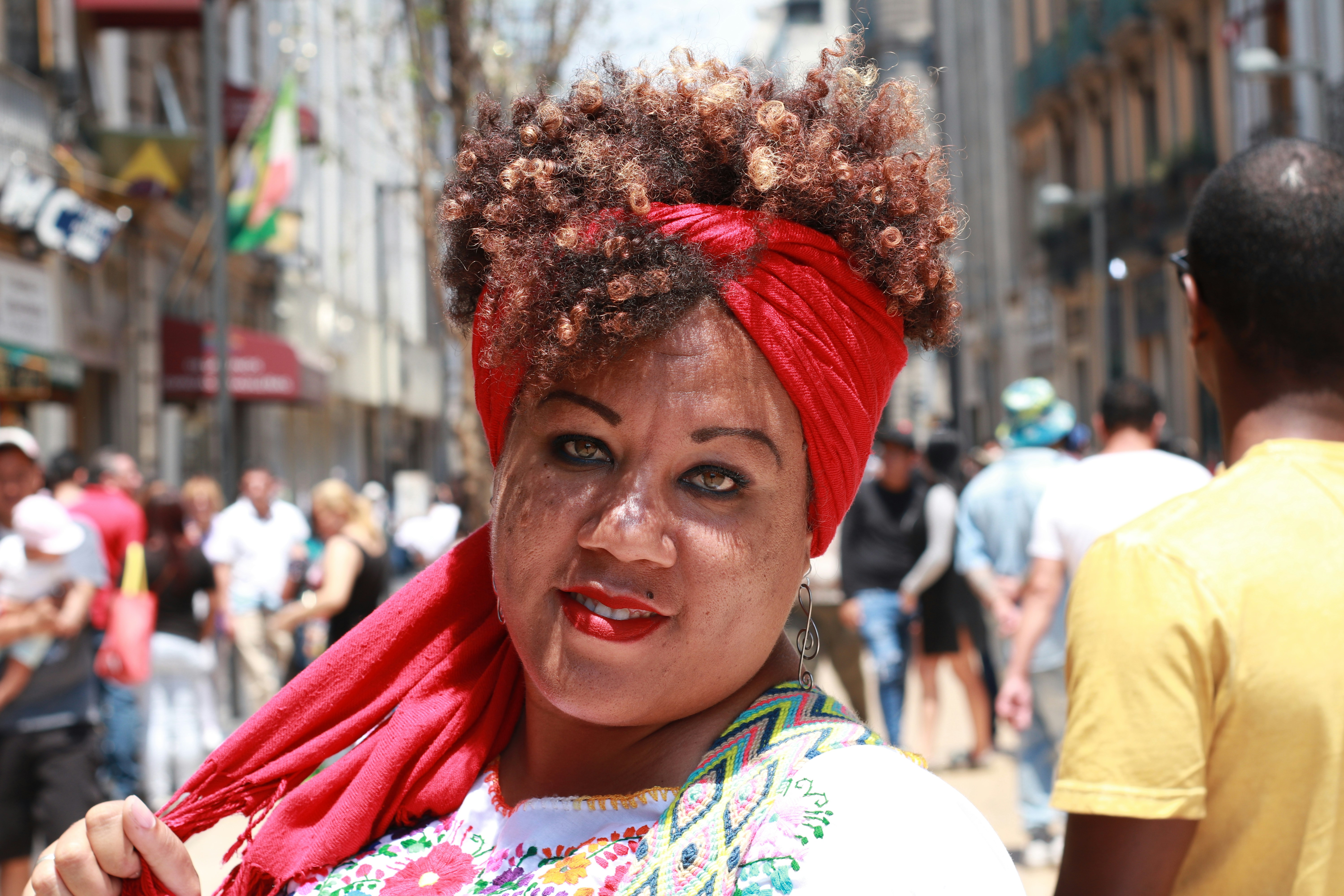 Vivid Street Portrait: Red Turban, Bright Smile in a Bustling City
