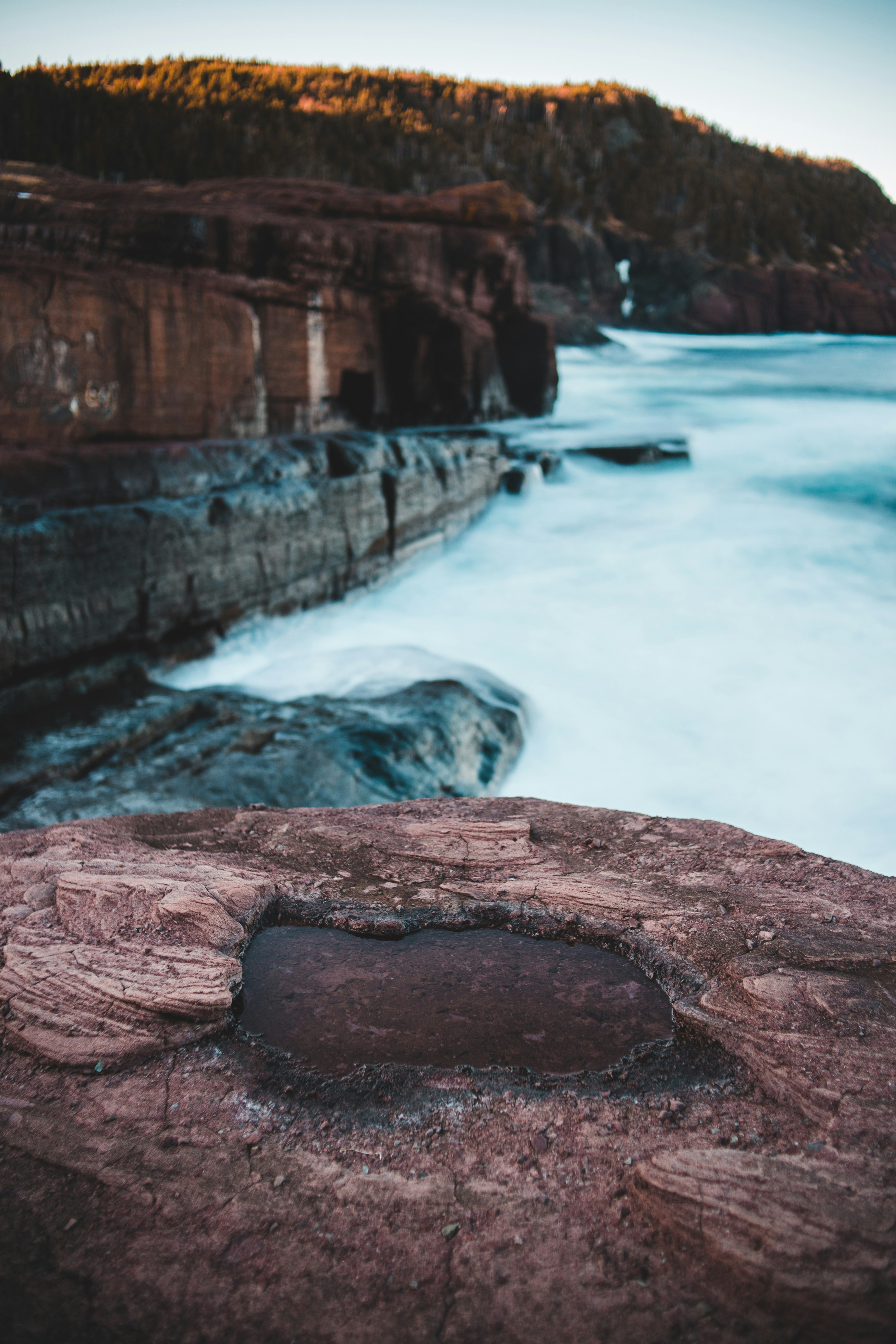 Rugged Coastal Cliff with a Weathered Foreground Puddle