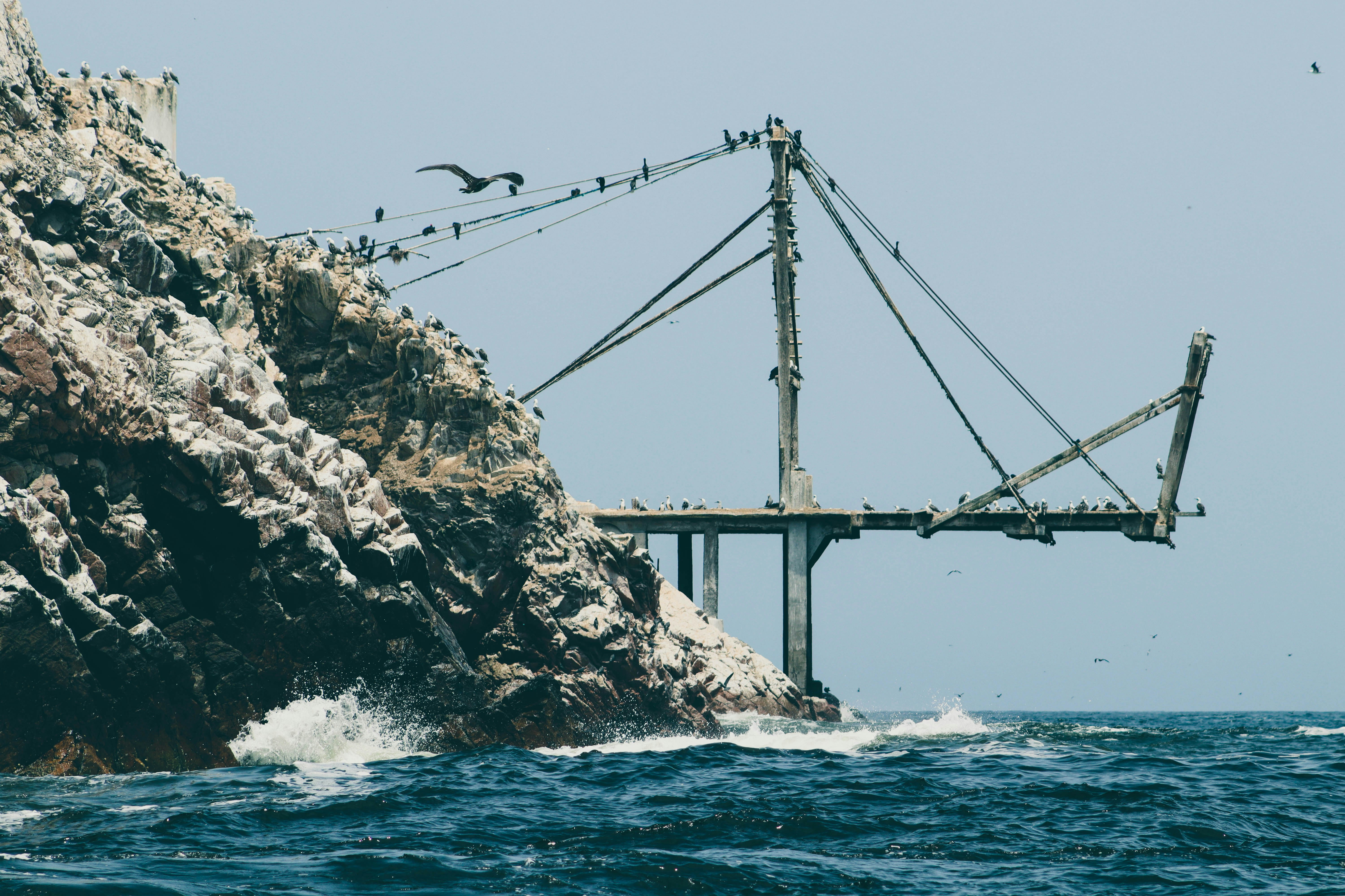 Rusted Gantry Over Ocean Cliffs