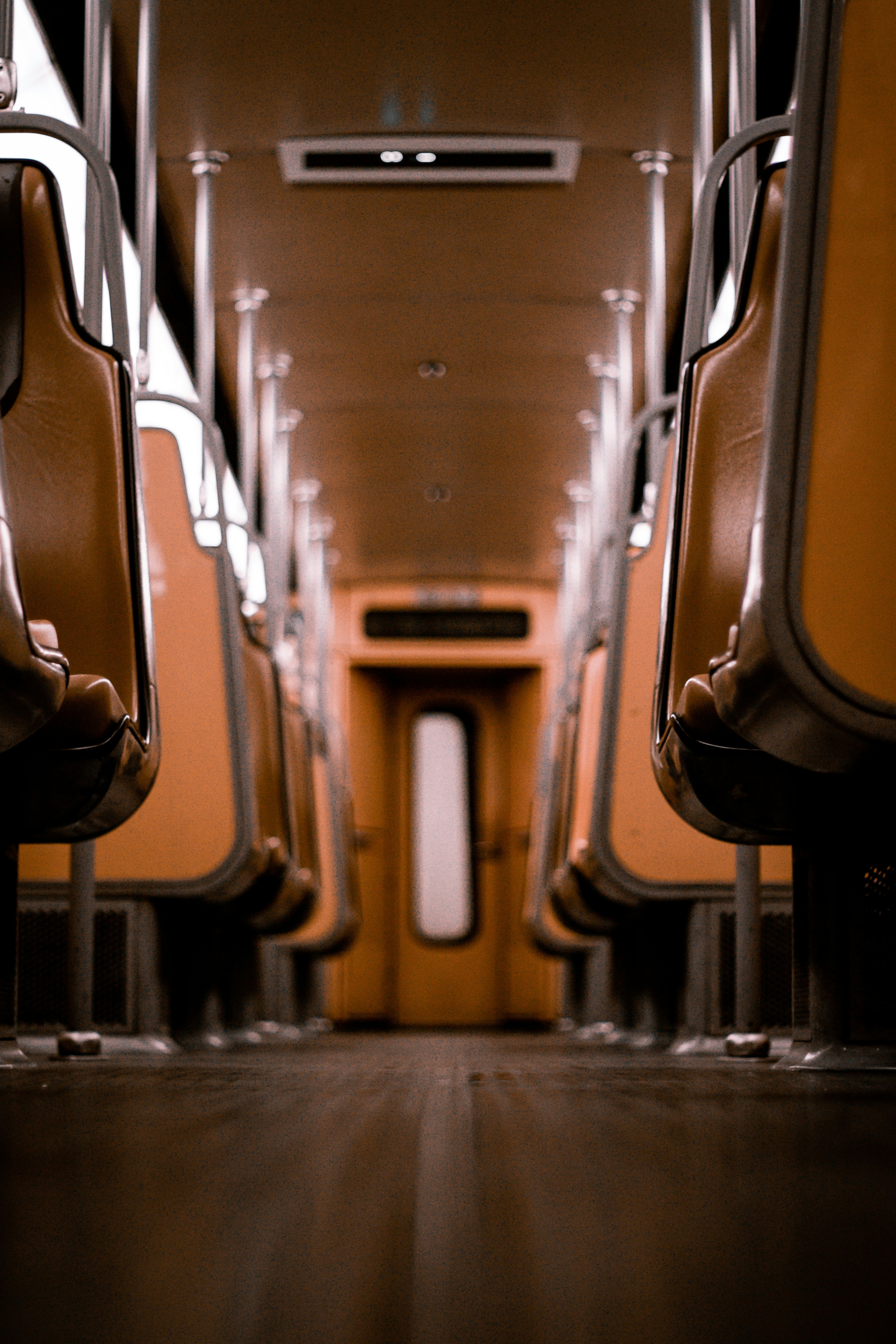 Vanishing Door Down an Orange-Seat Aisle