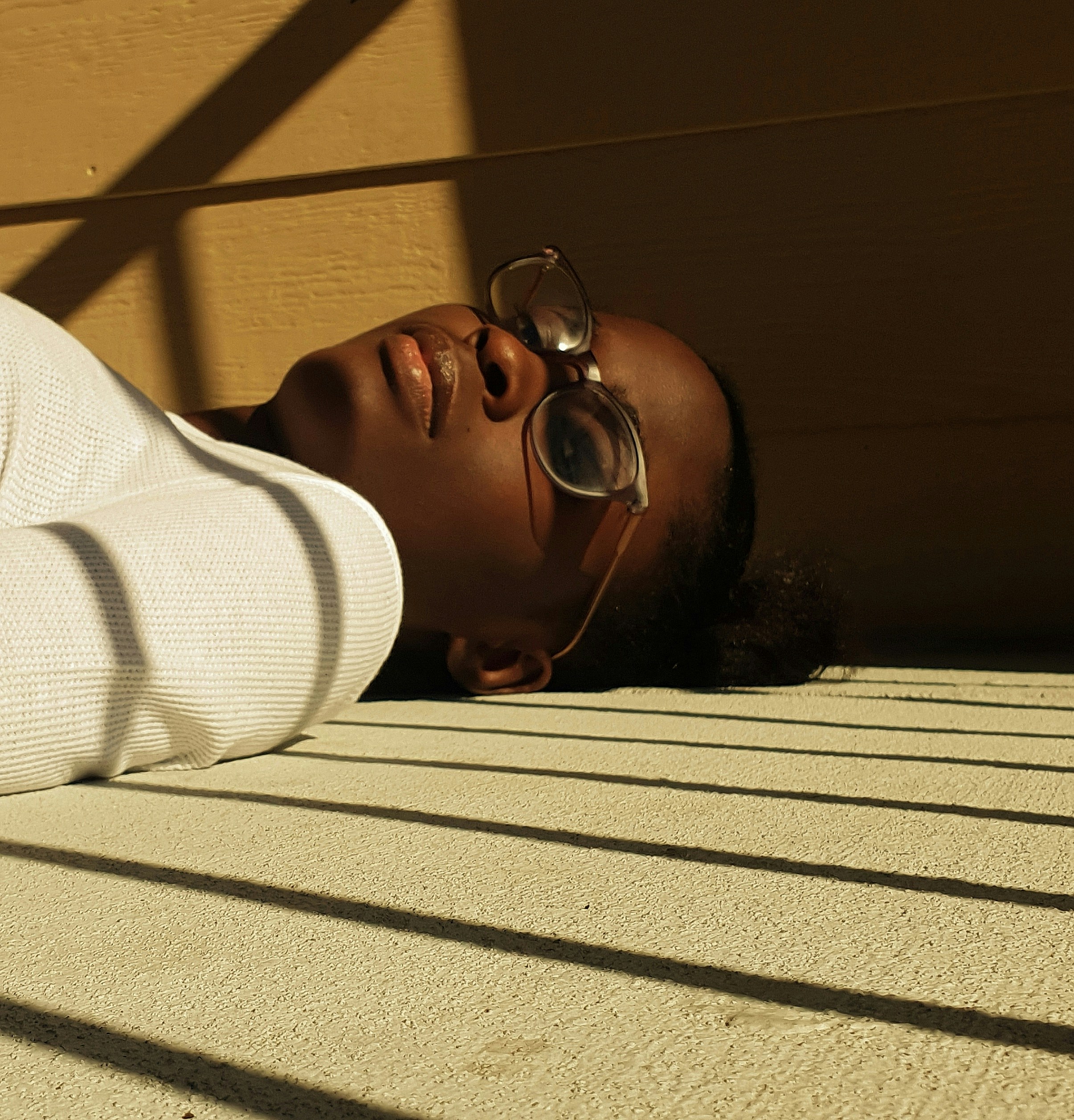 Sunlit Stripes: A Quiet Portrait on Warm Concrete