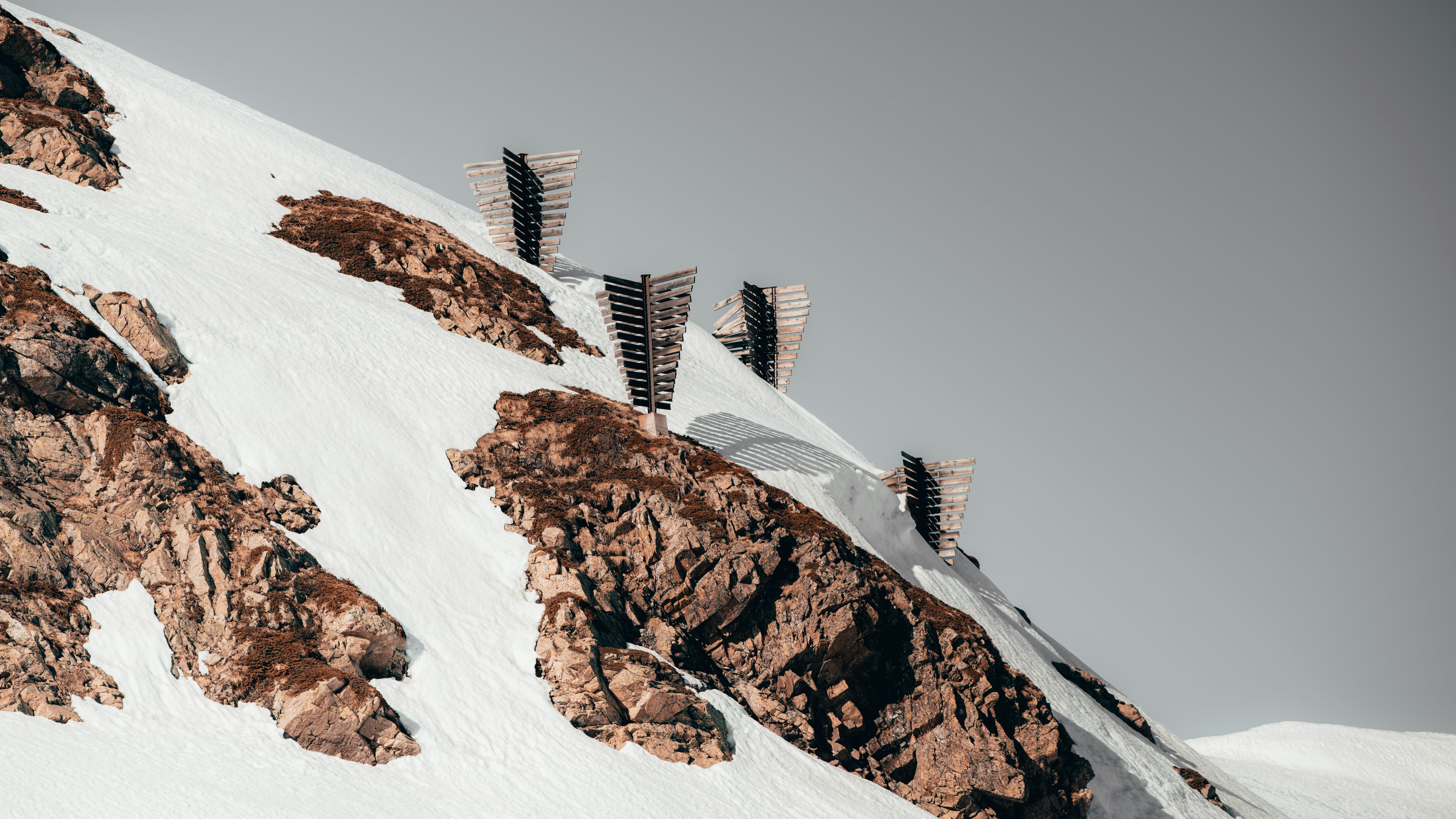 Triangular Silhouettes Along a Snowbound Alpine Ridge