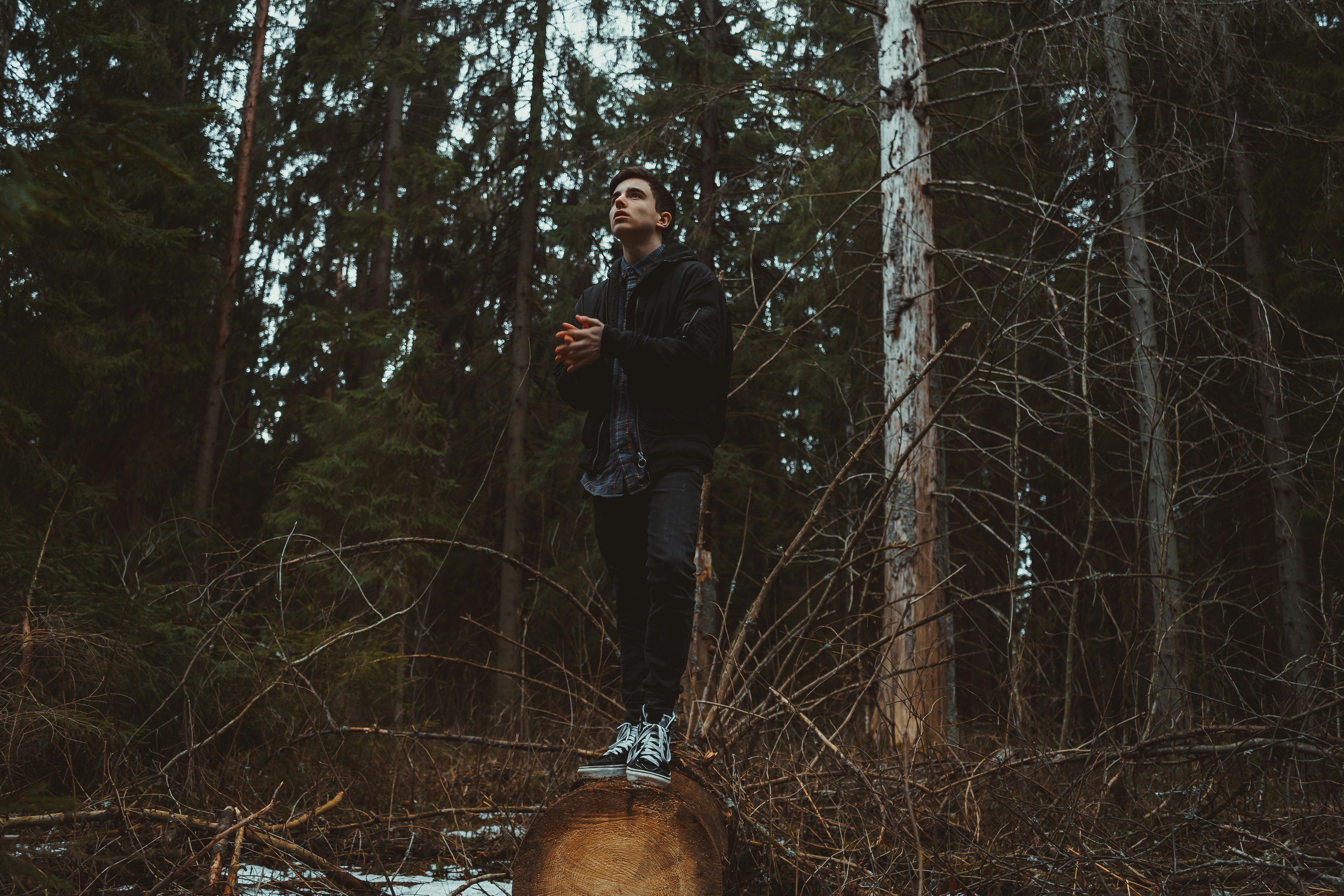 Man in black jacket standing on forest during daytime photo – Free ...
