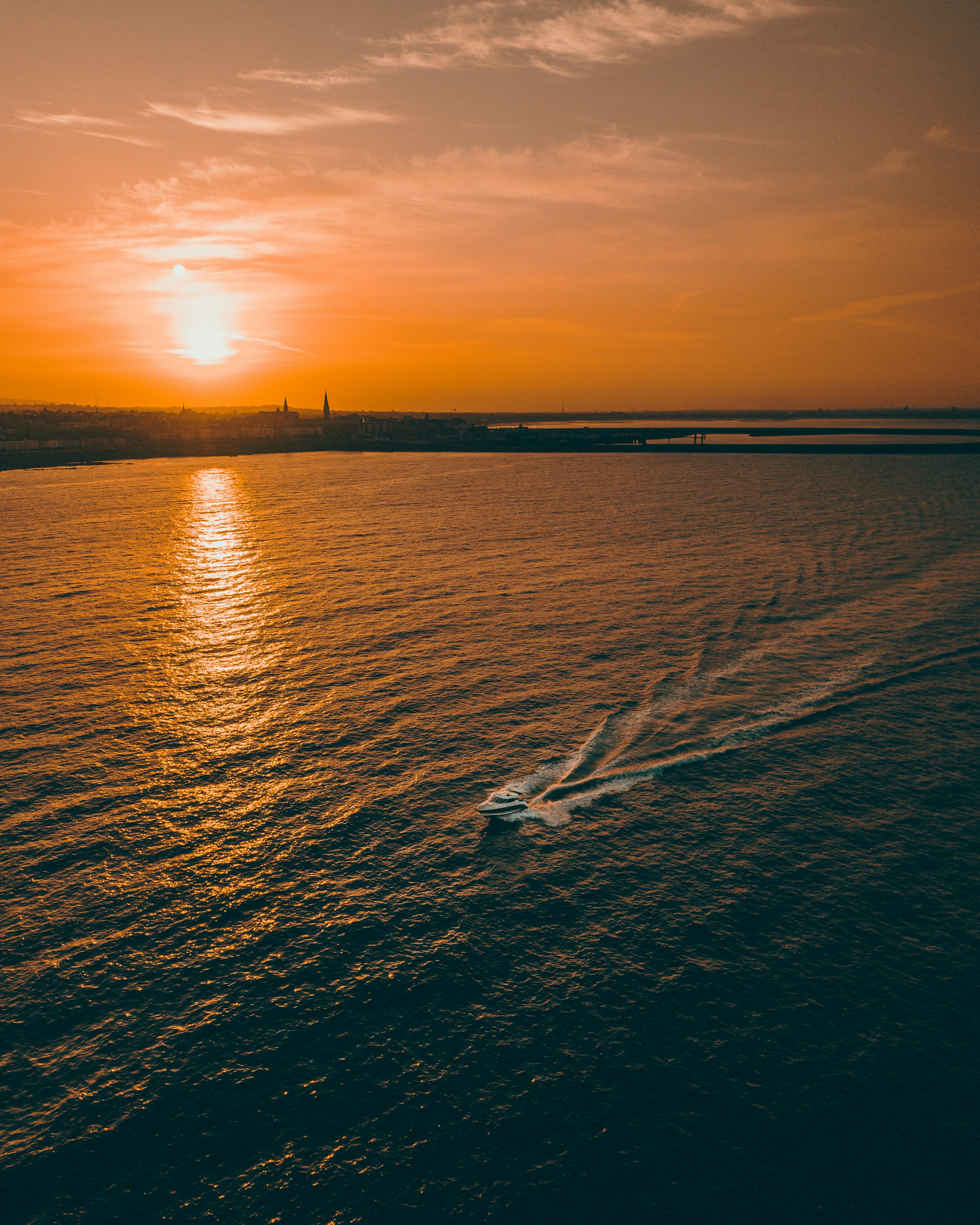Citrine Horizon: Sunset Over Quiet Currents Seen from Above