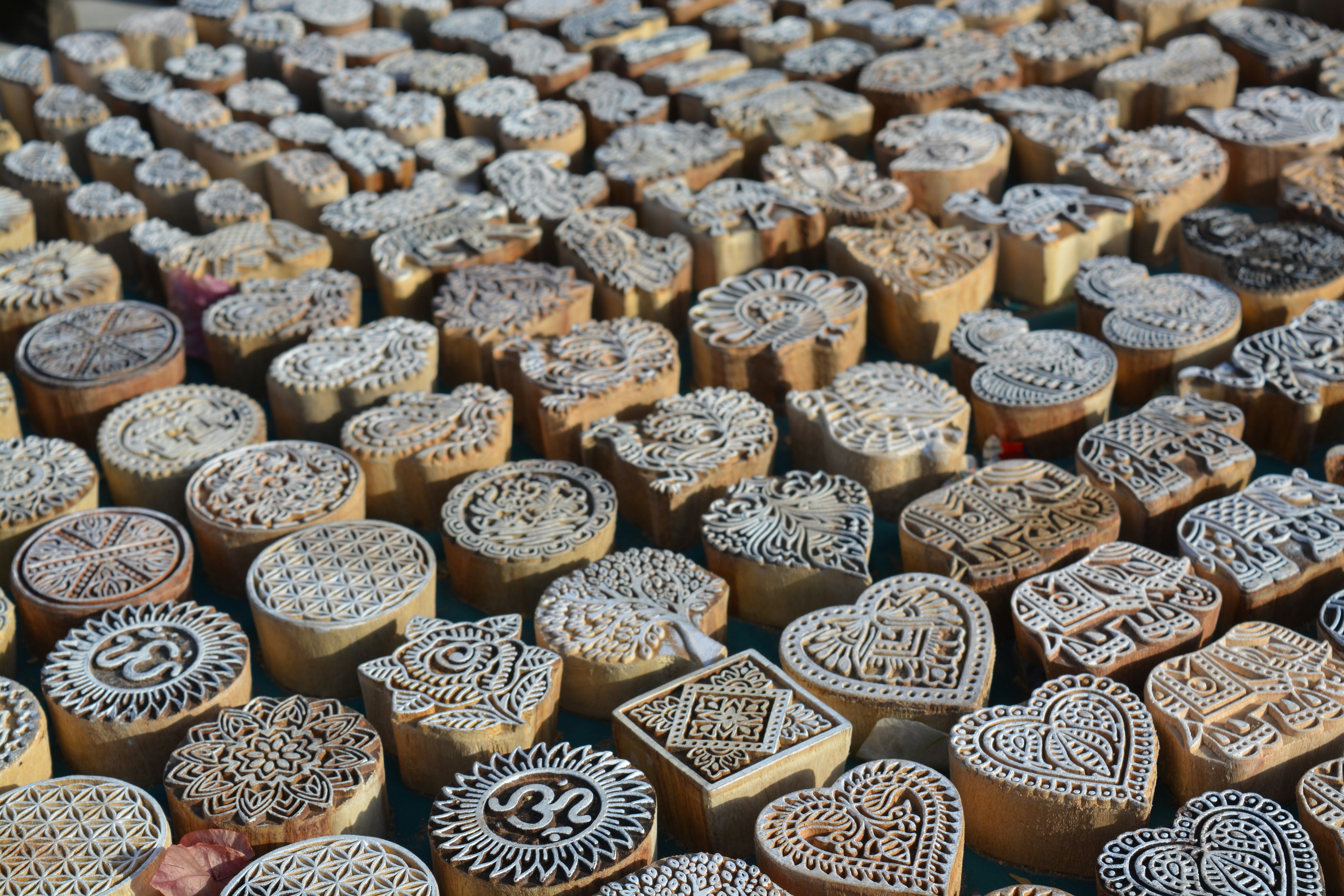 Array of intricately carved wooden printing blocks with diverse designs.