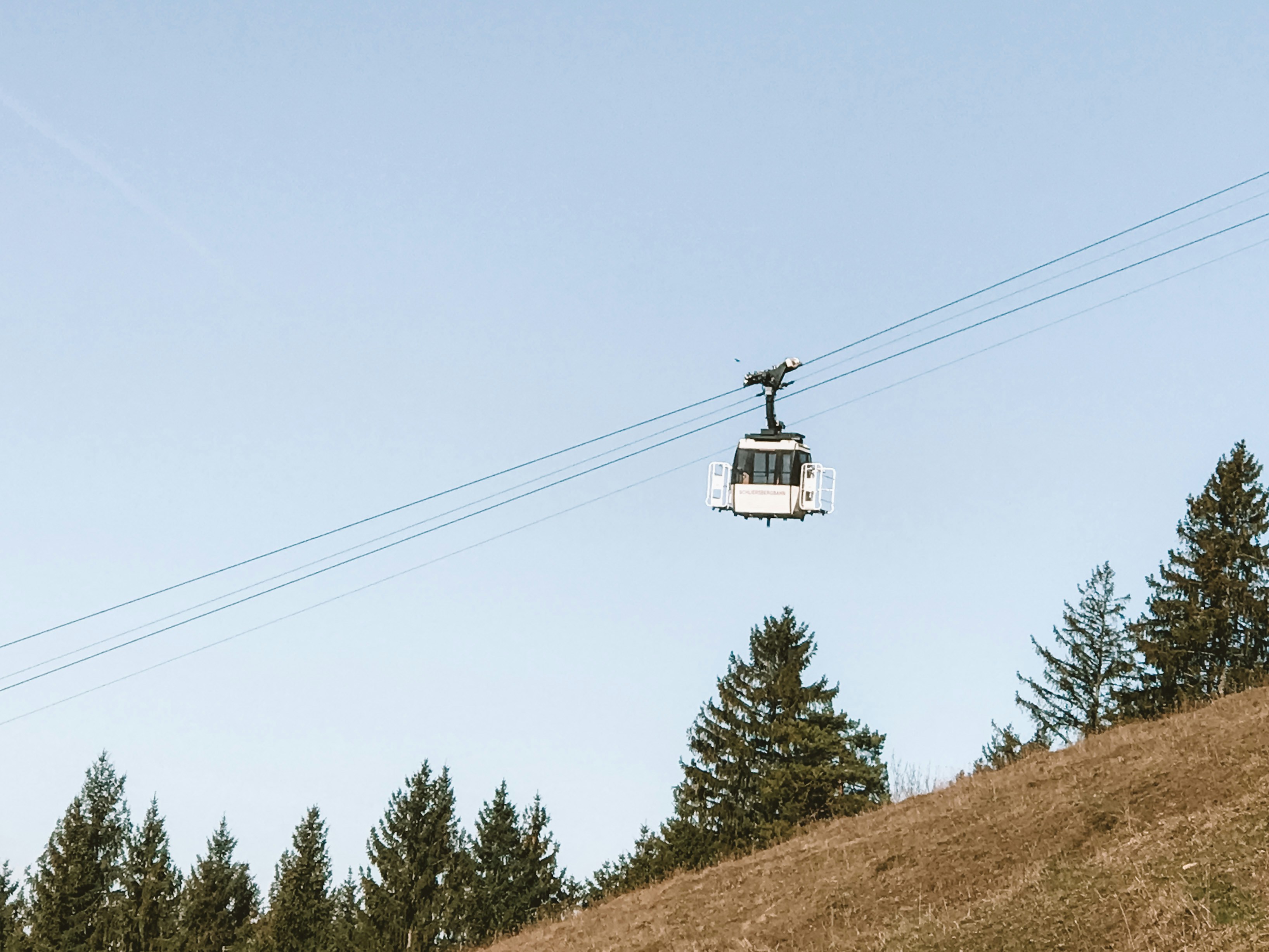 White cable car over green trees during daytime photo – Free Blue Image ...