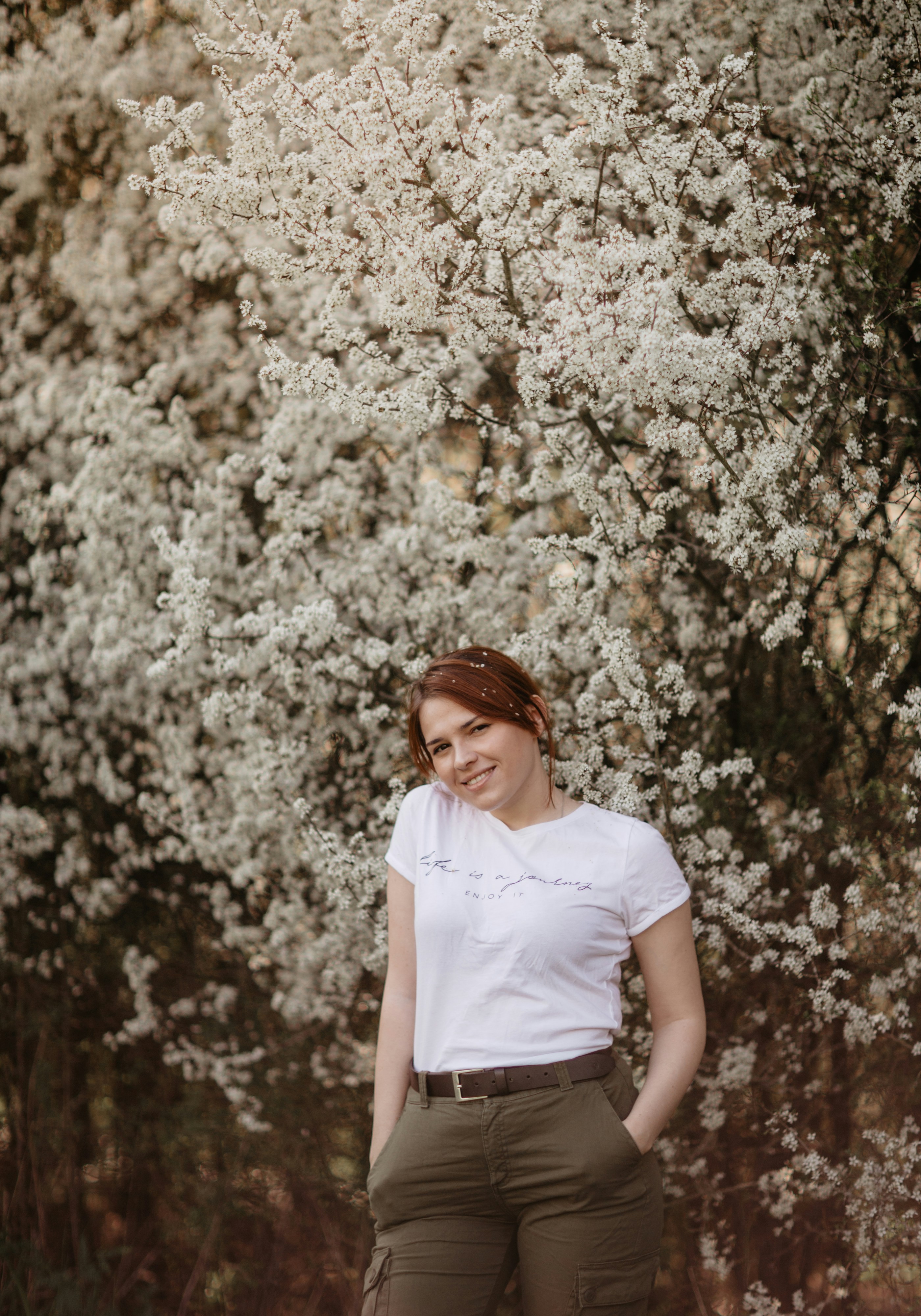 Blossoms & Confidence: A Portrait Beneath Whispering White