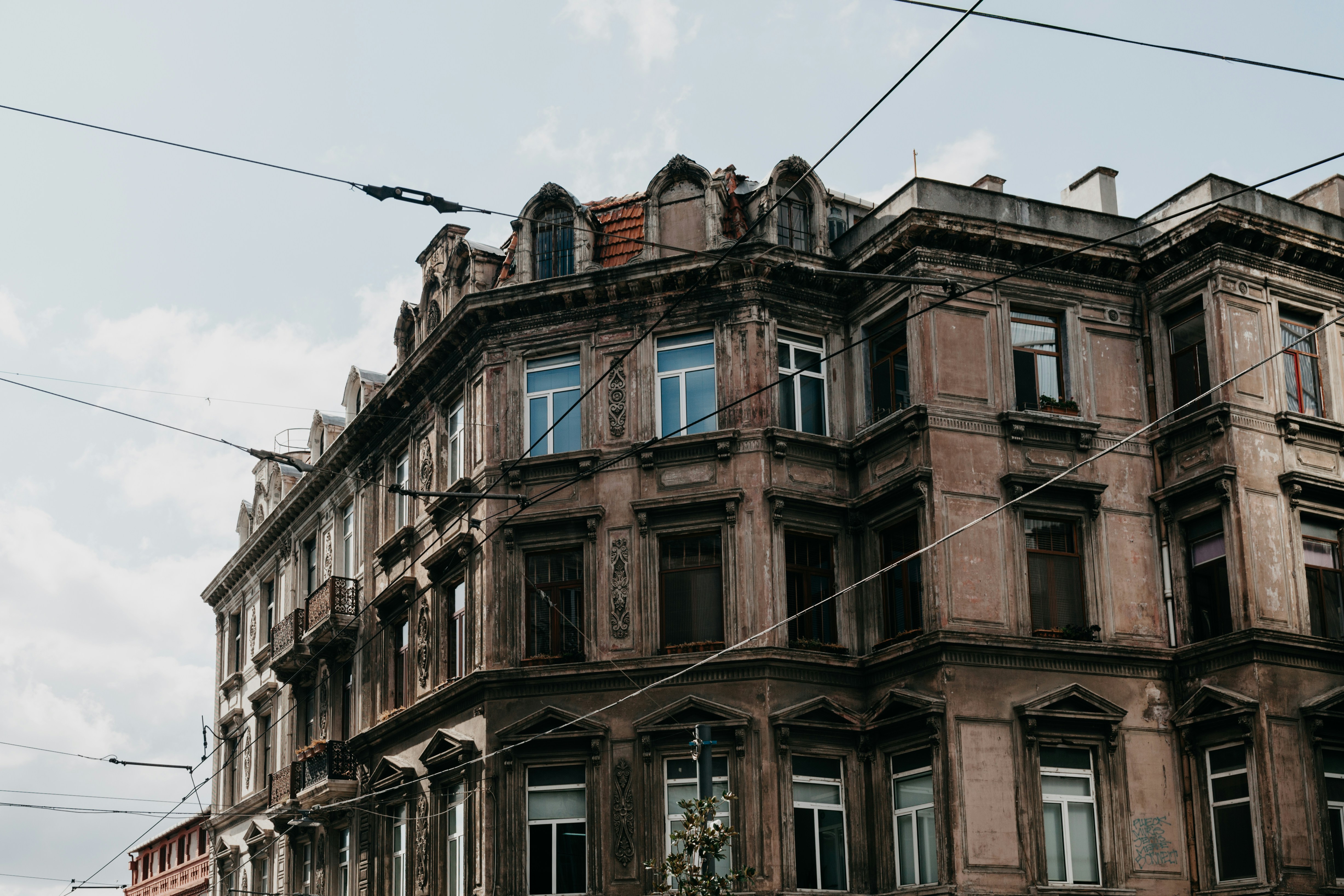 Historic brown stone building with detailed architecture under a clear blue sky.