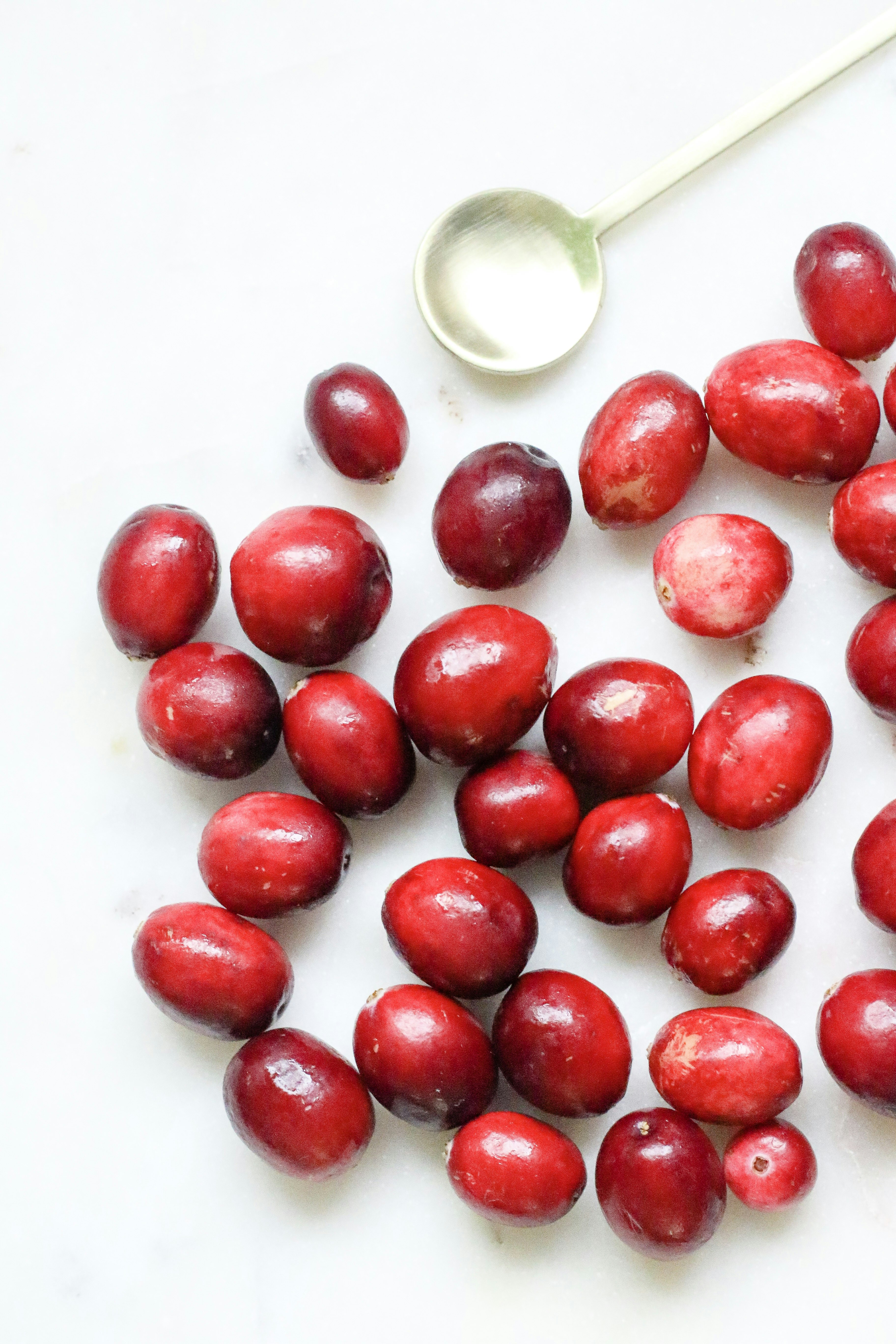 Red round fruits on white surface photo – Free Food Image on Unsplash
