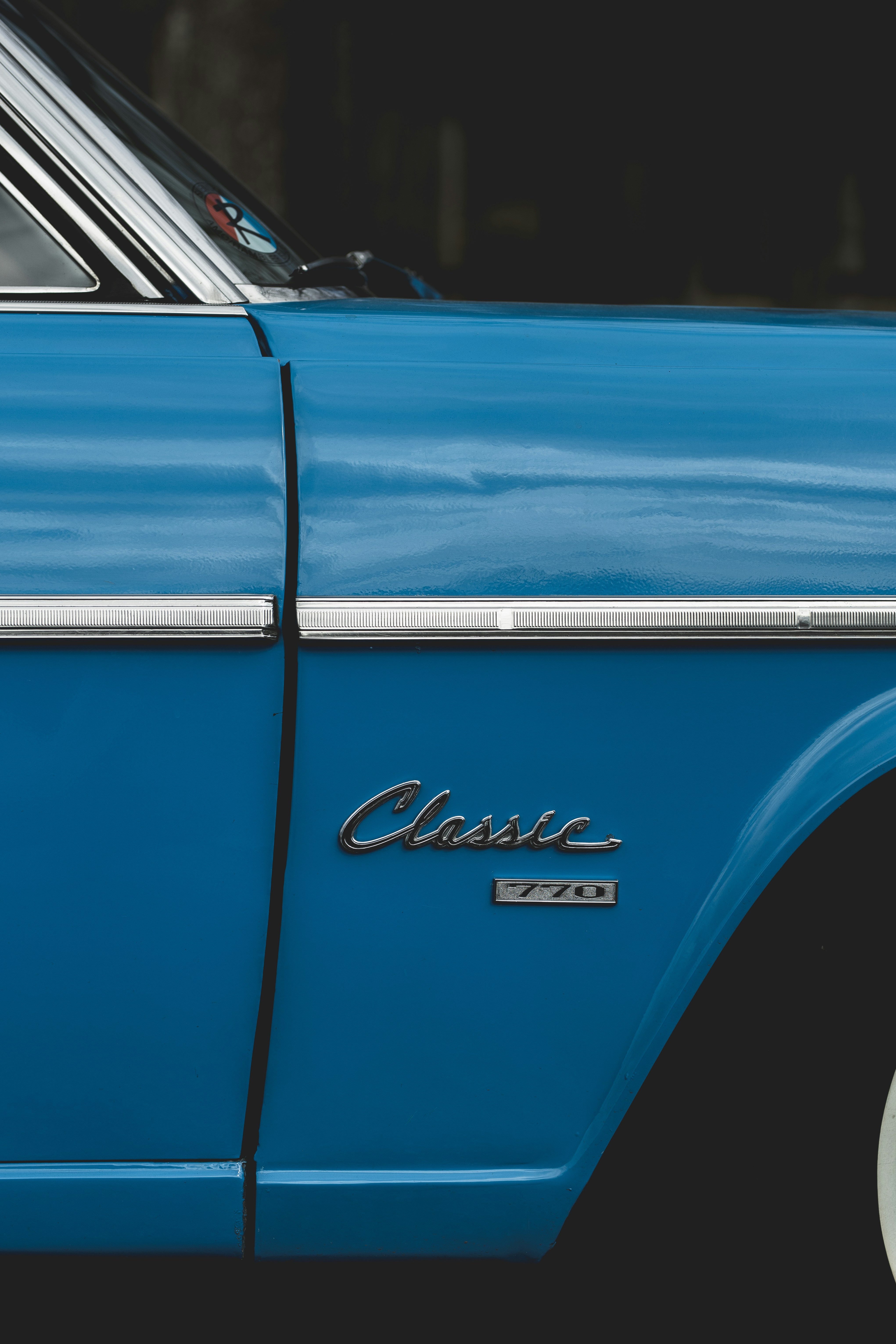 Cerulean Classic: Chrome Script Badge on a Vintage Car Door