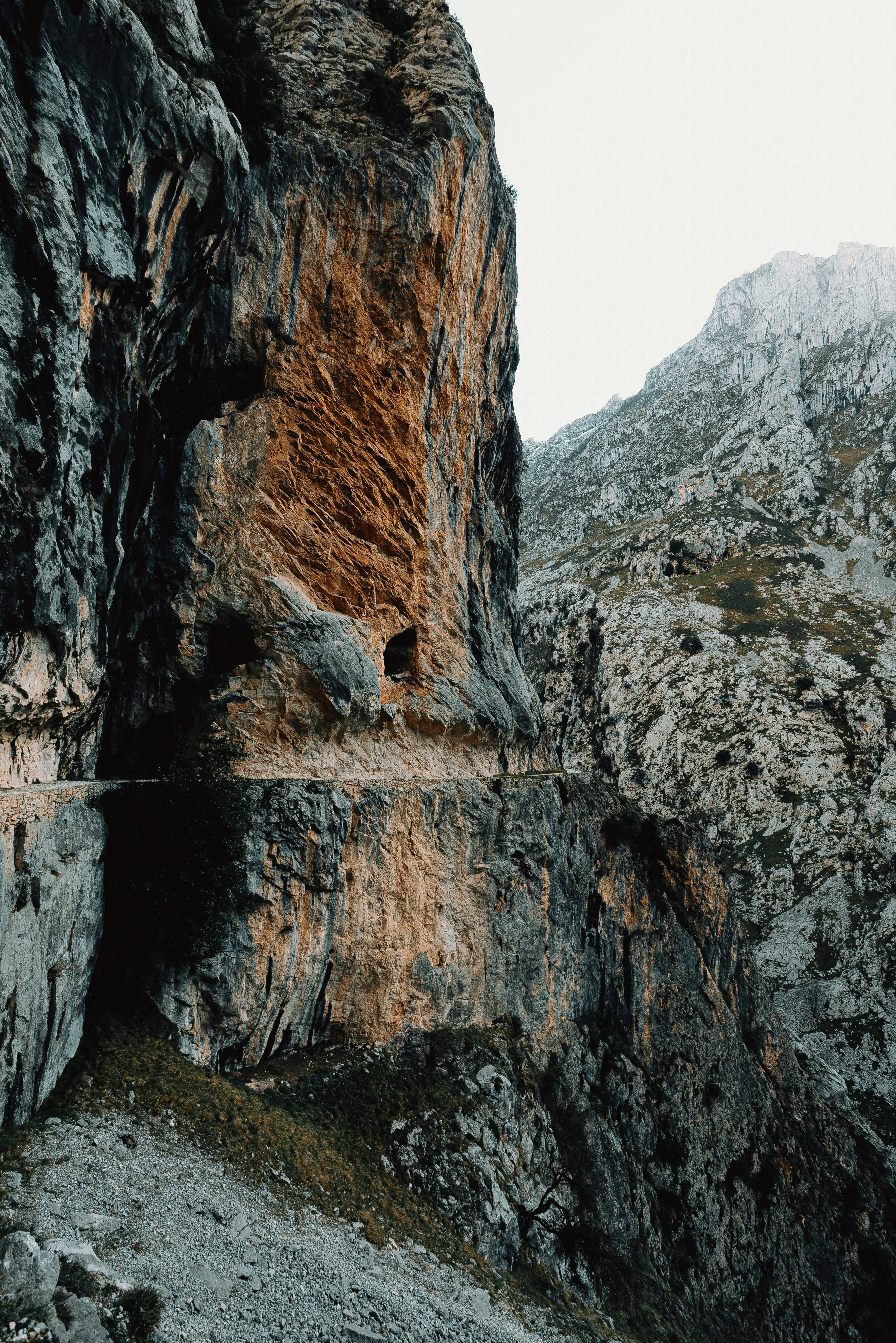 brown concrete stairs between rocky mountain during daytime