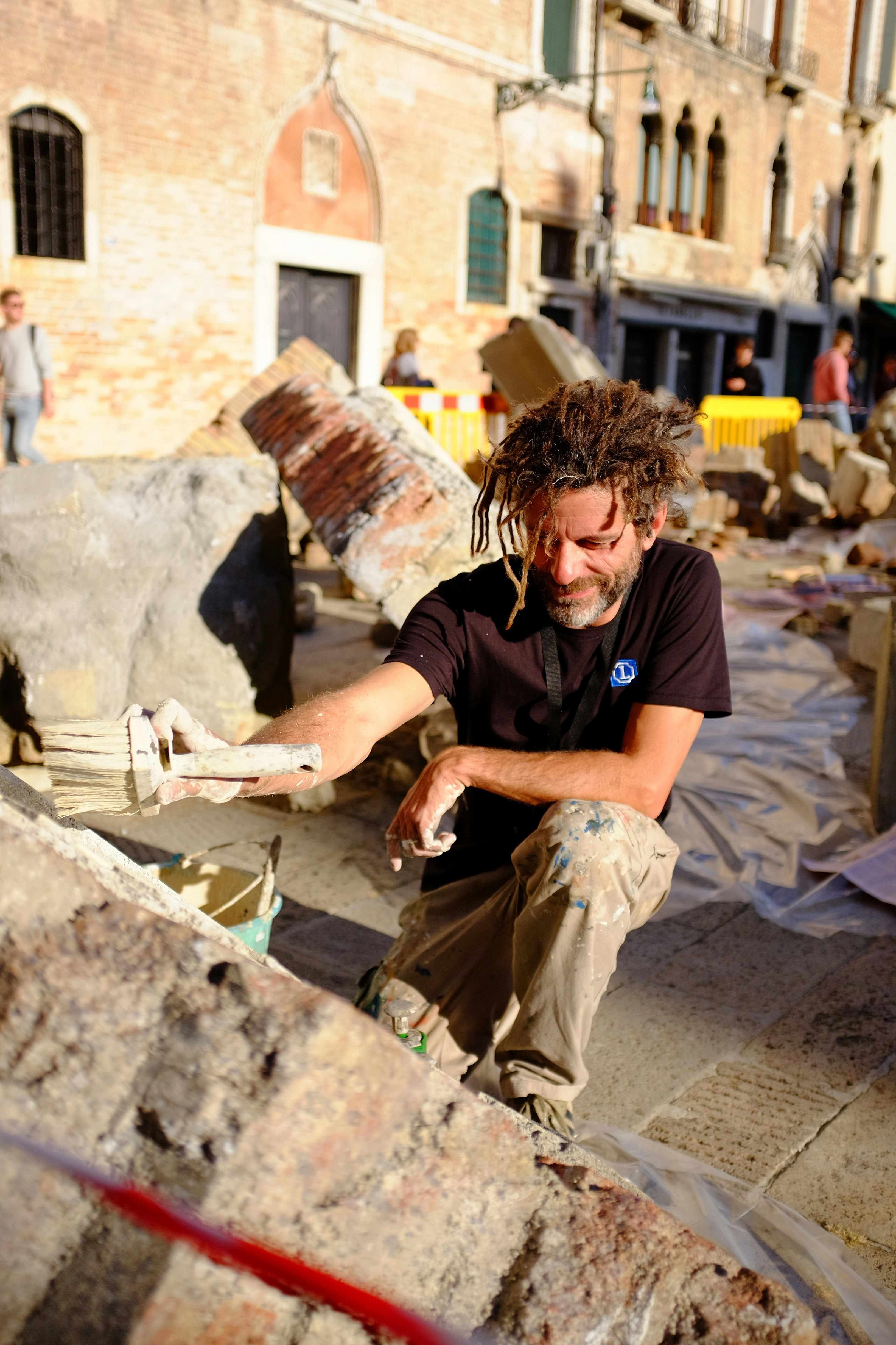 Sunlit Bricklayer in a Historic Street: Craft in Motion