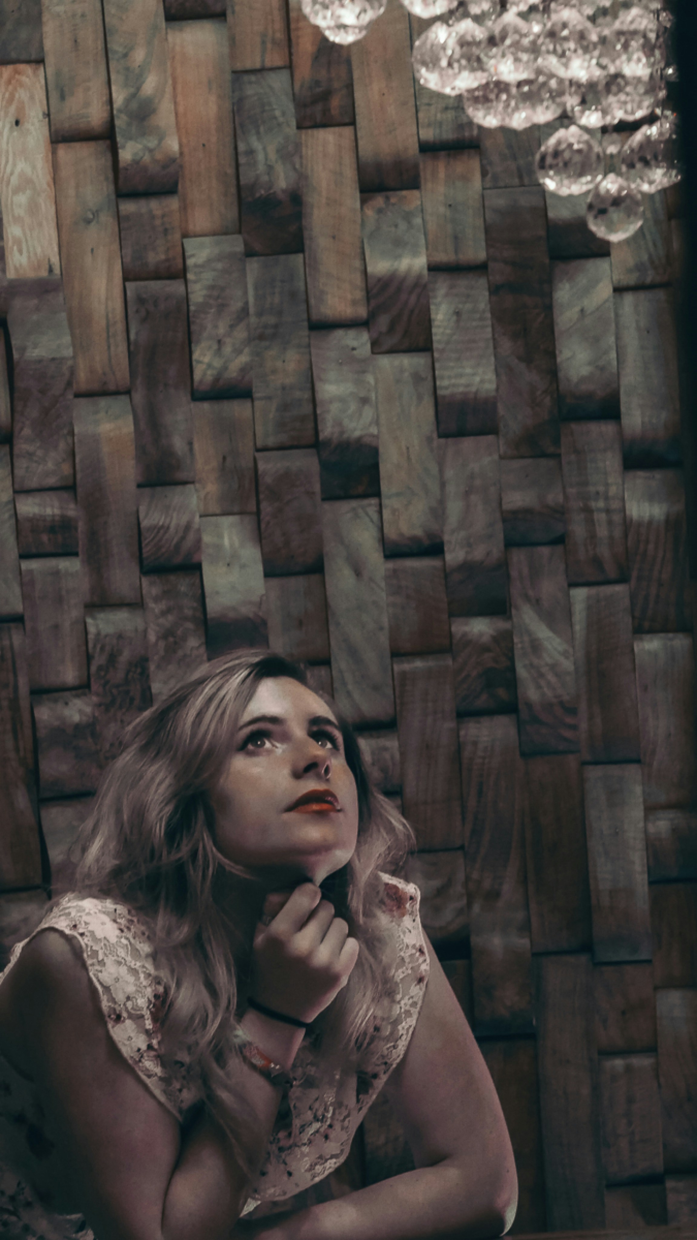 Gleam in the Wooden Hall: A Quiet Portrait beneath Crystal Light