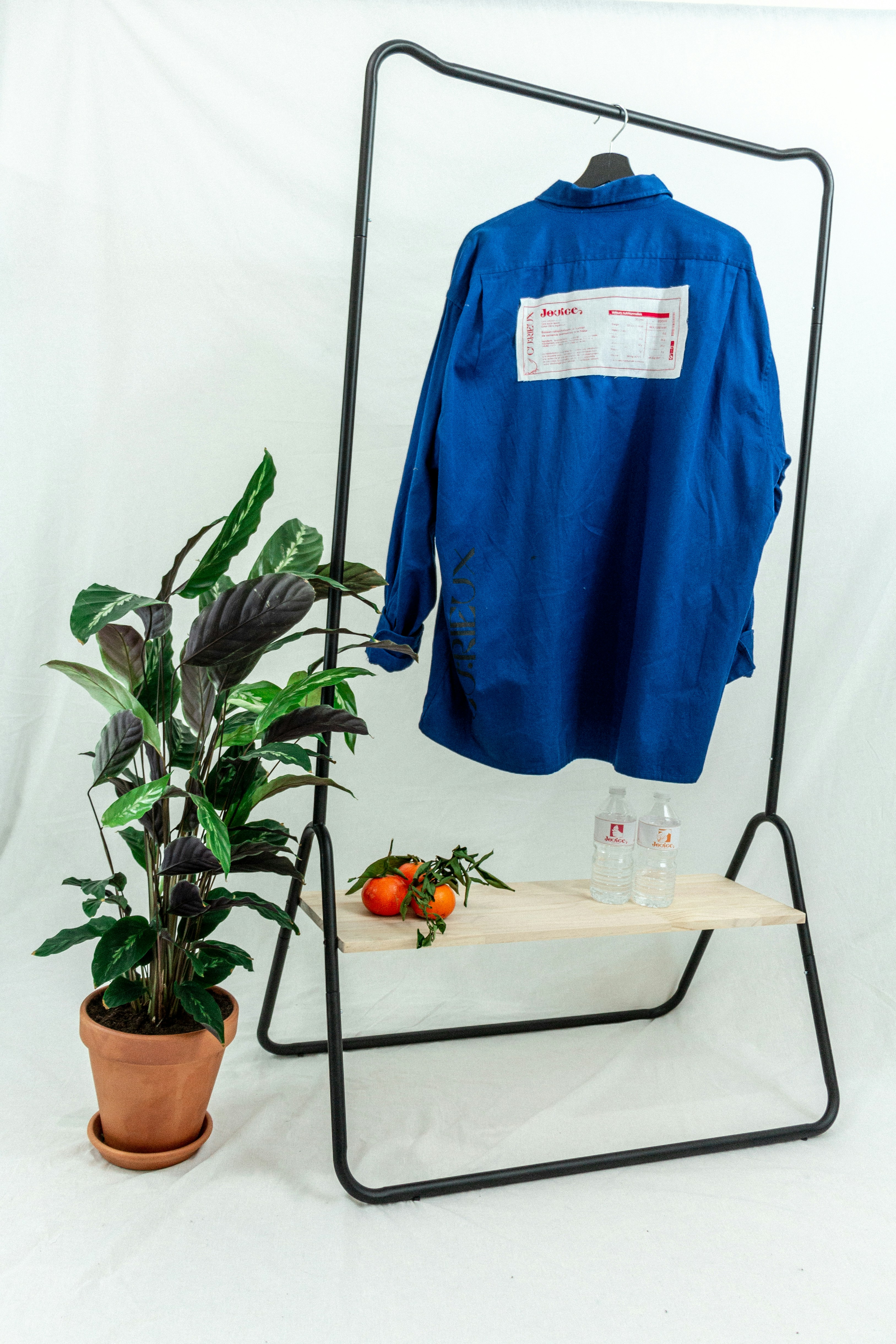 blue polo shirt on black steel chair