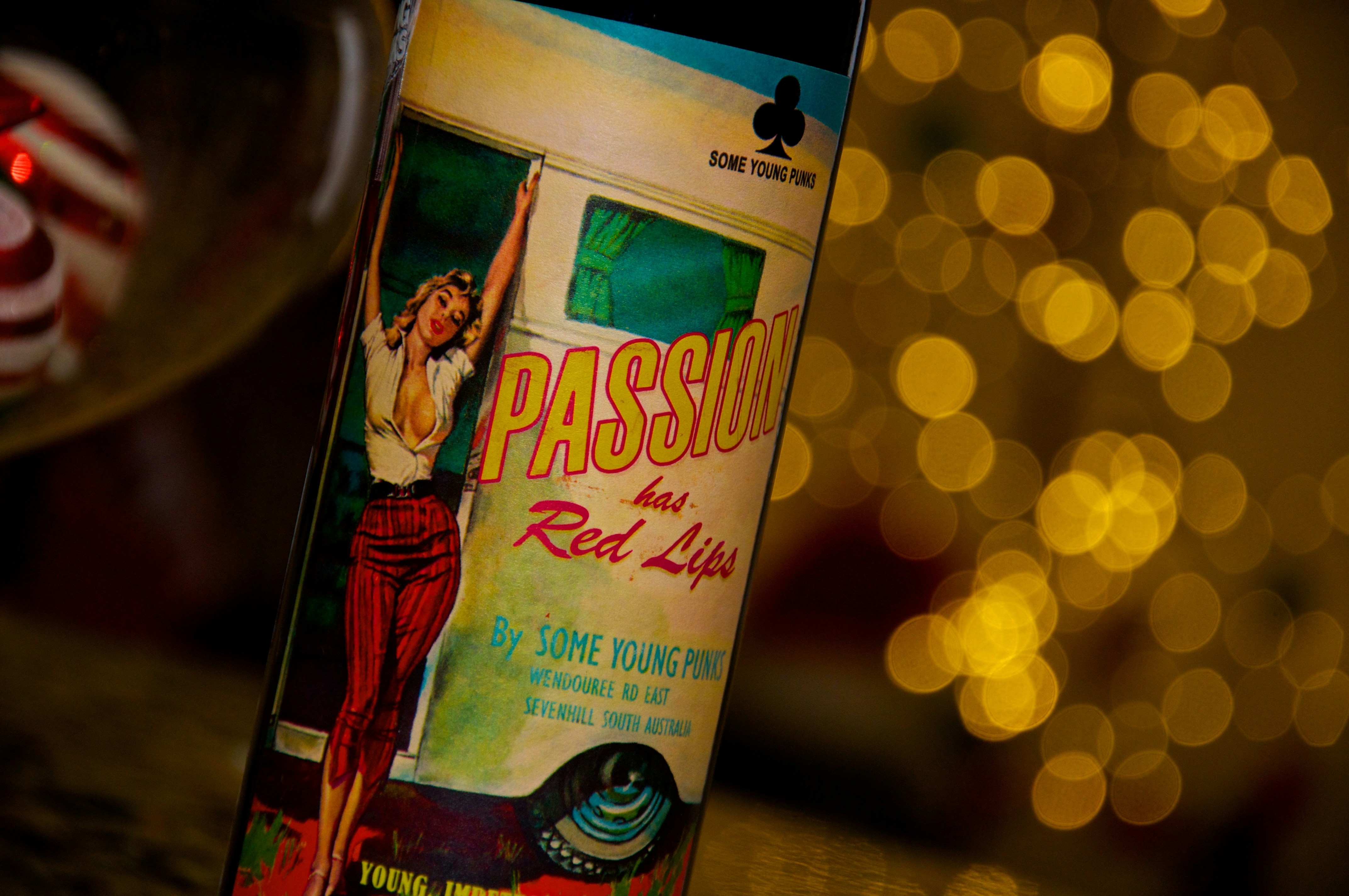 Retro-style wine bottle with festive bokeh lights in the background.