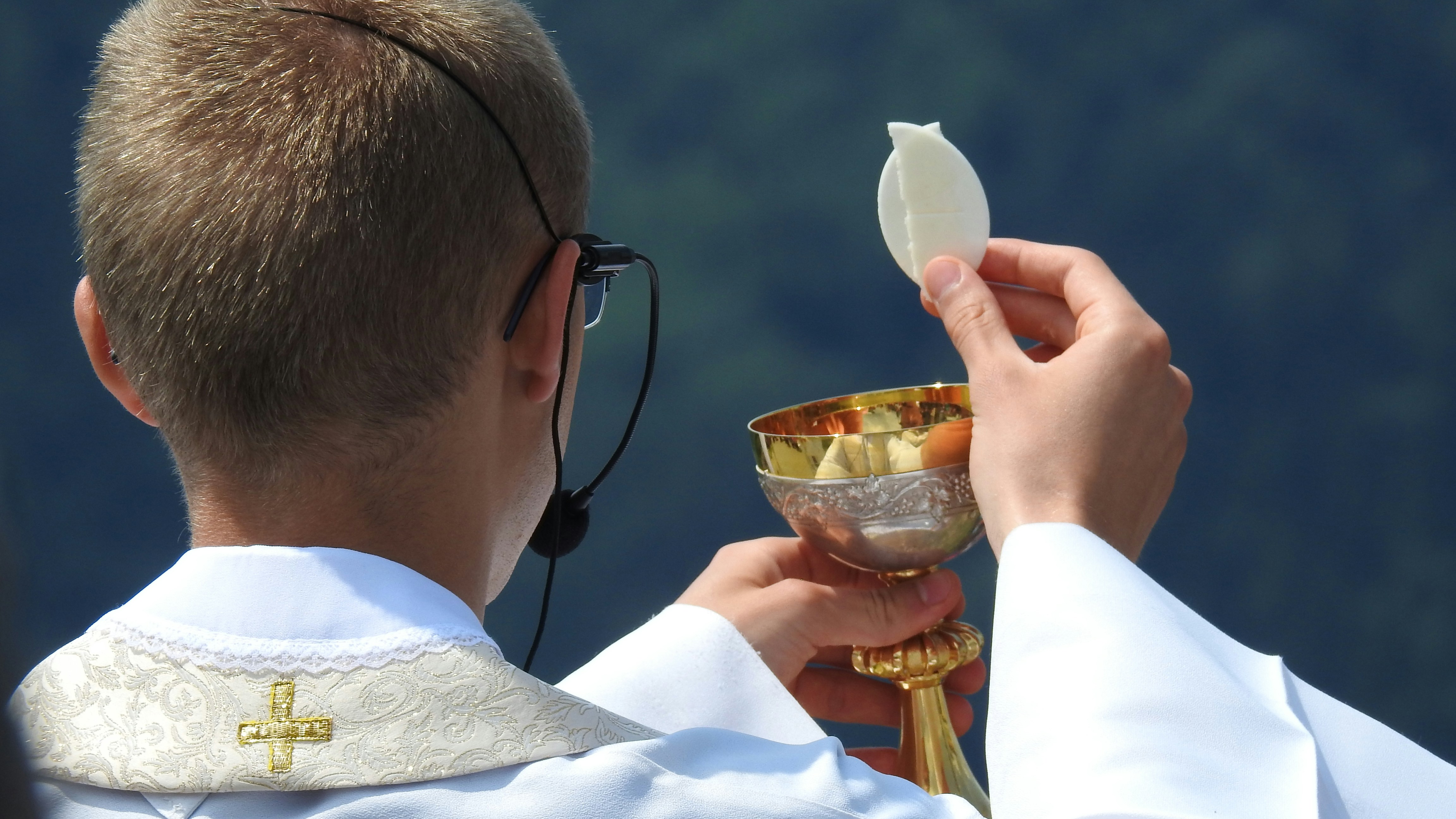 Blessing in the Mountain Air: Elevating the Host Over a Golden Chalice